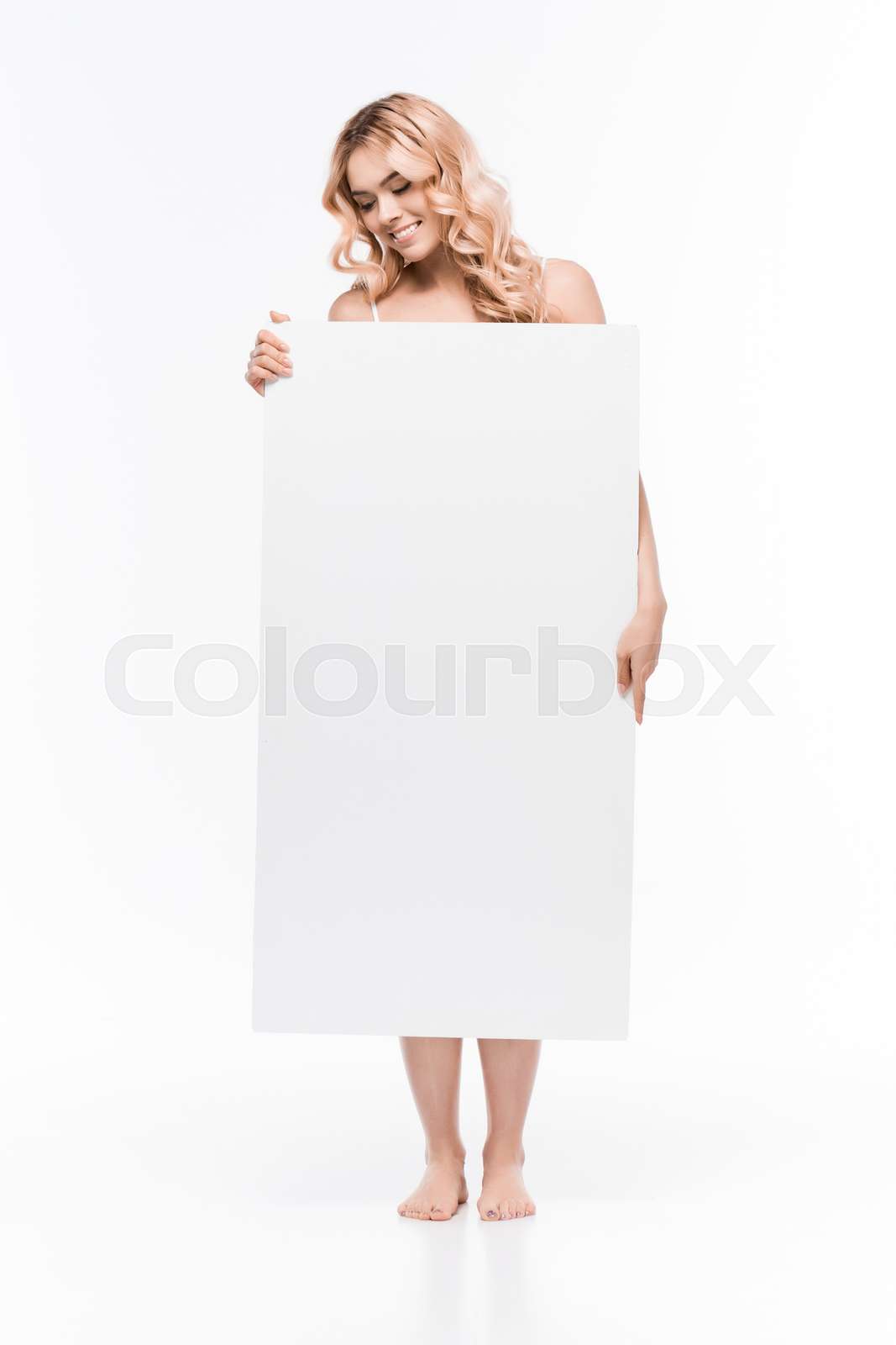 woman covering body with blank banner in hands isolated on white ...