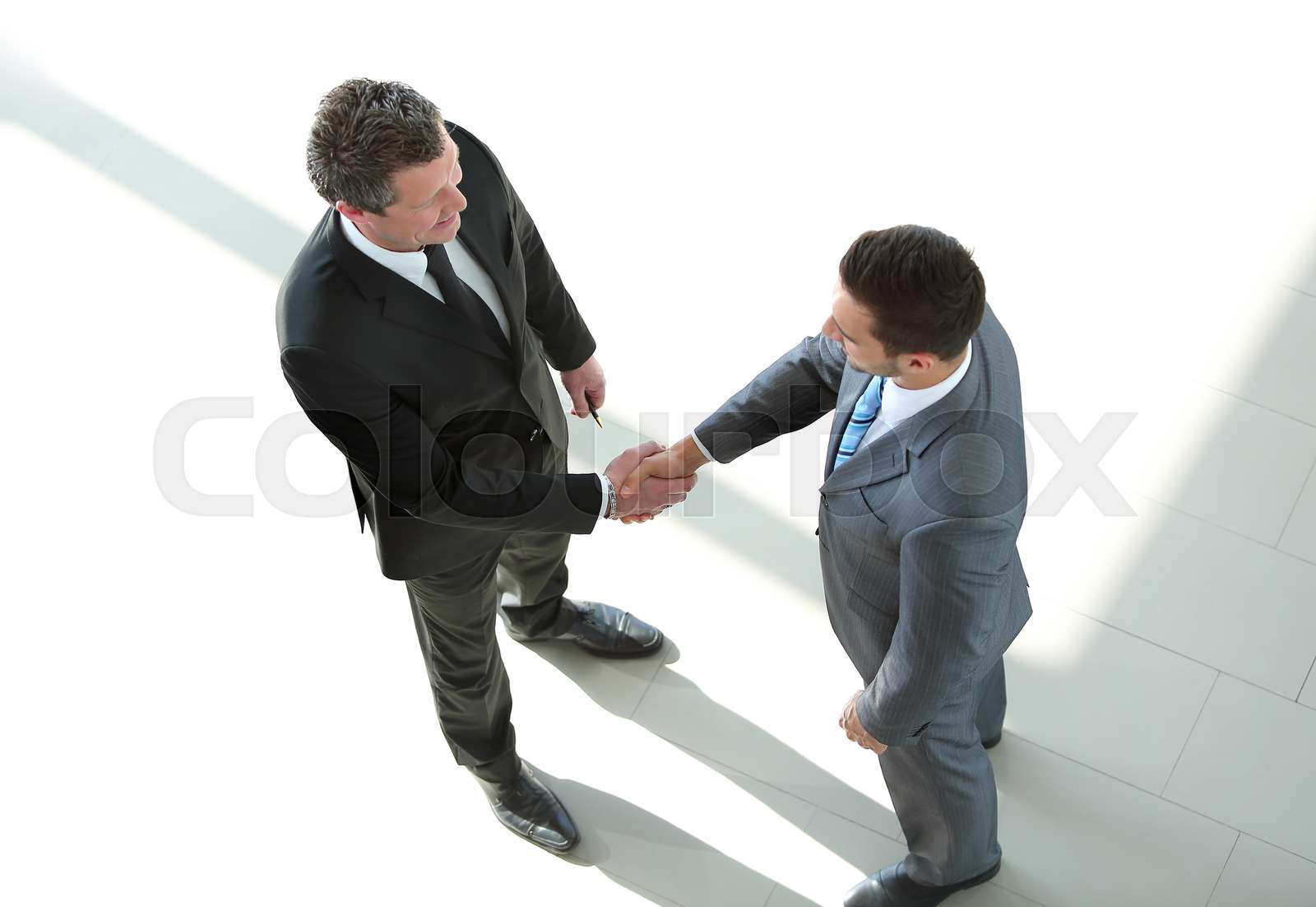 Business people closing a deal and handshaking at the office | Stock ...