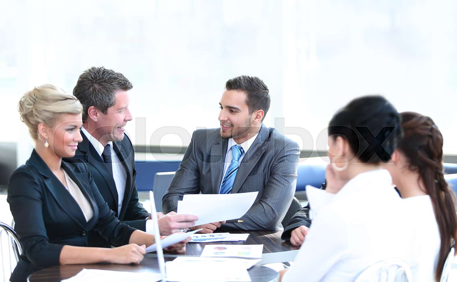 Business people working around table in modern office | Stock image ...