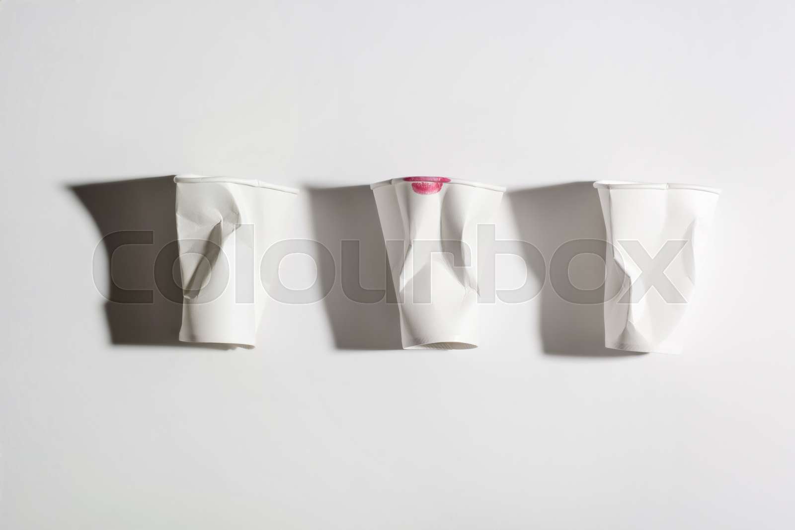 top view of three crumpled used paper cups isolated on white | Stock ...
