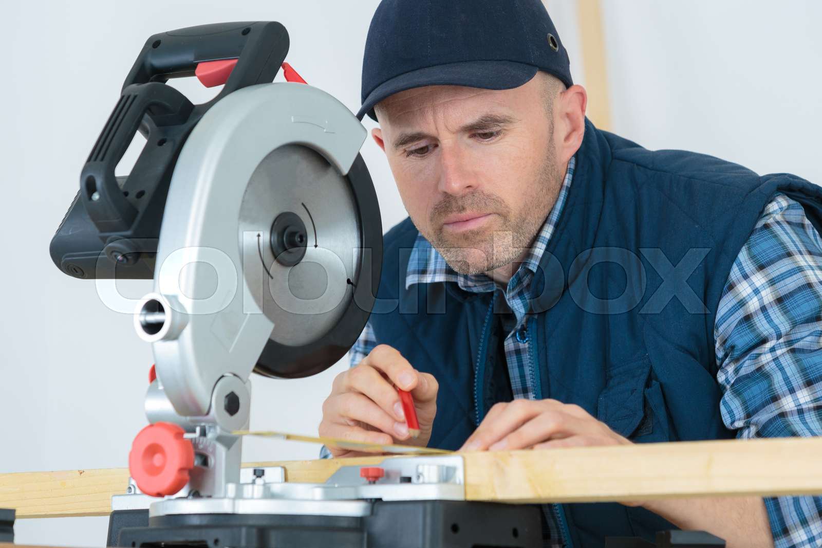 industrial worker preparing to cut metal with circular saw | Stock ...