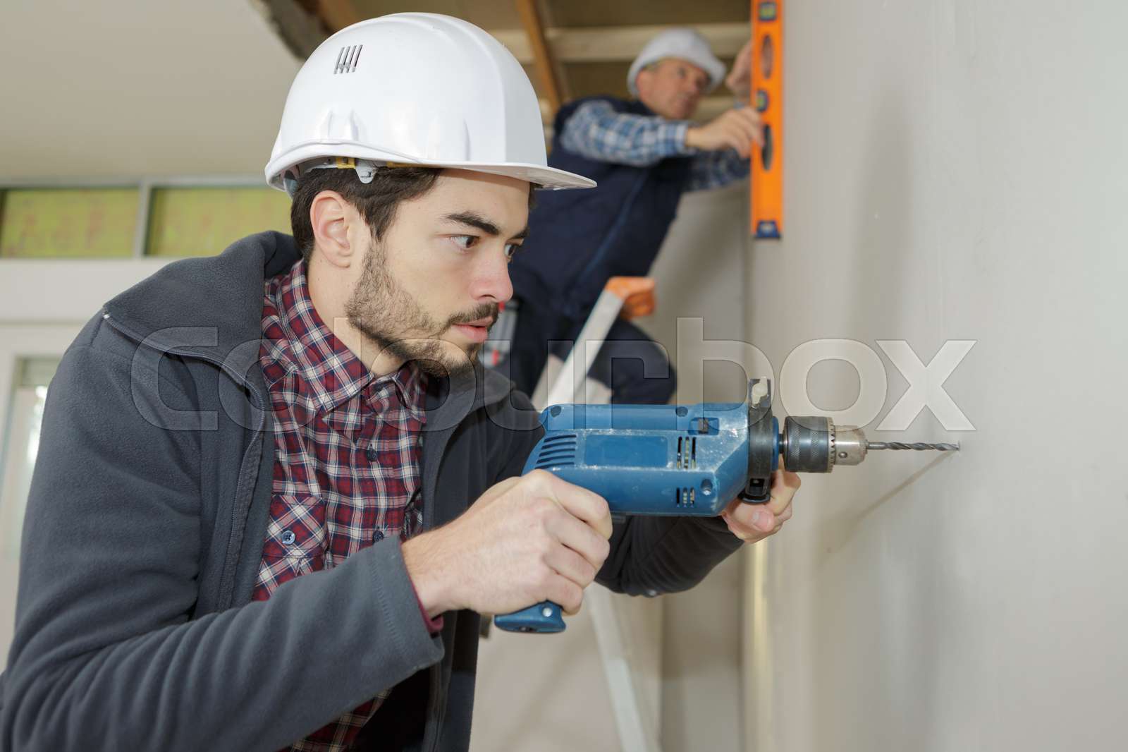 construction site workers drilling with a machine or drill | Stock ...