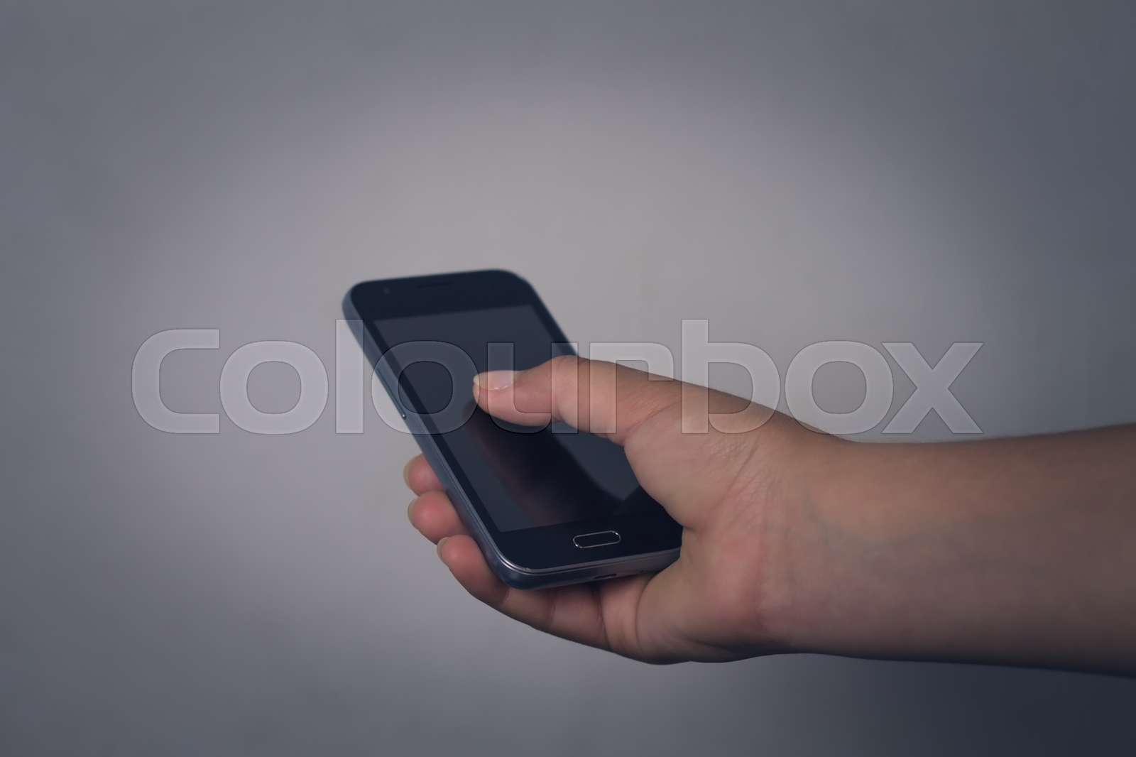 Hand holding phone. | Stock image | Colourbox
