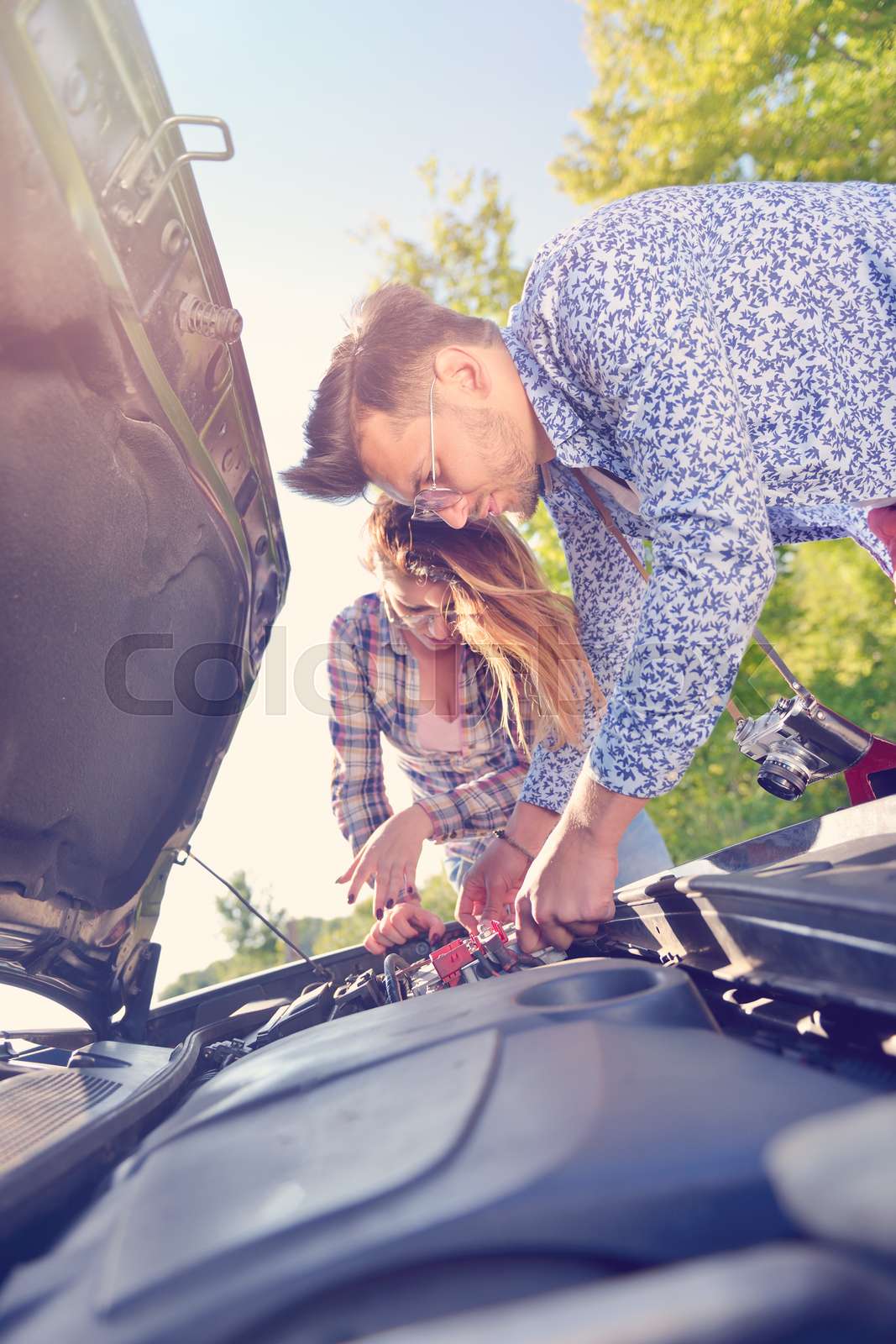 Young couple on the road has problems with their car | Stock image ...