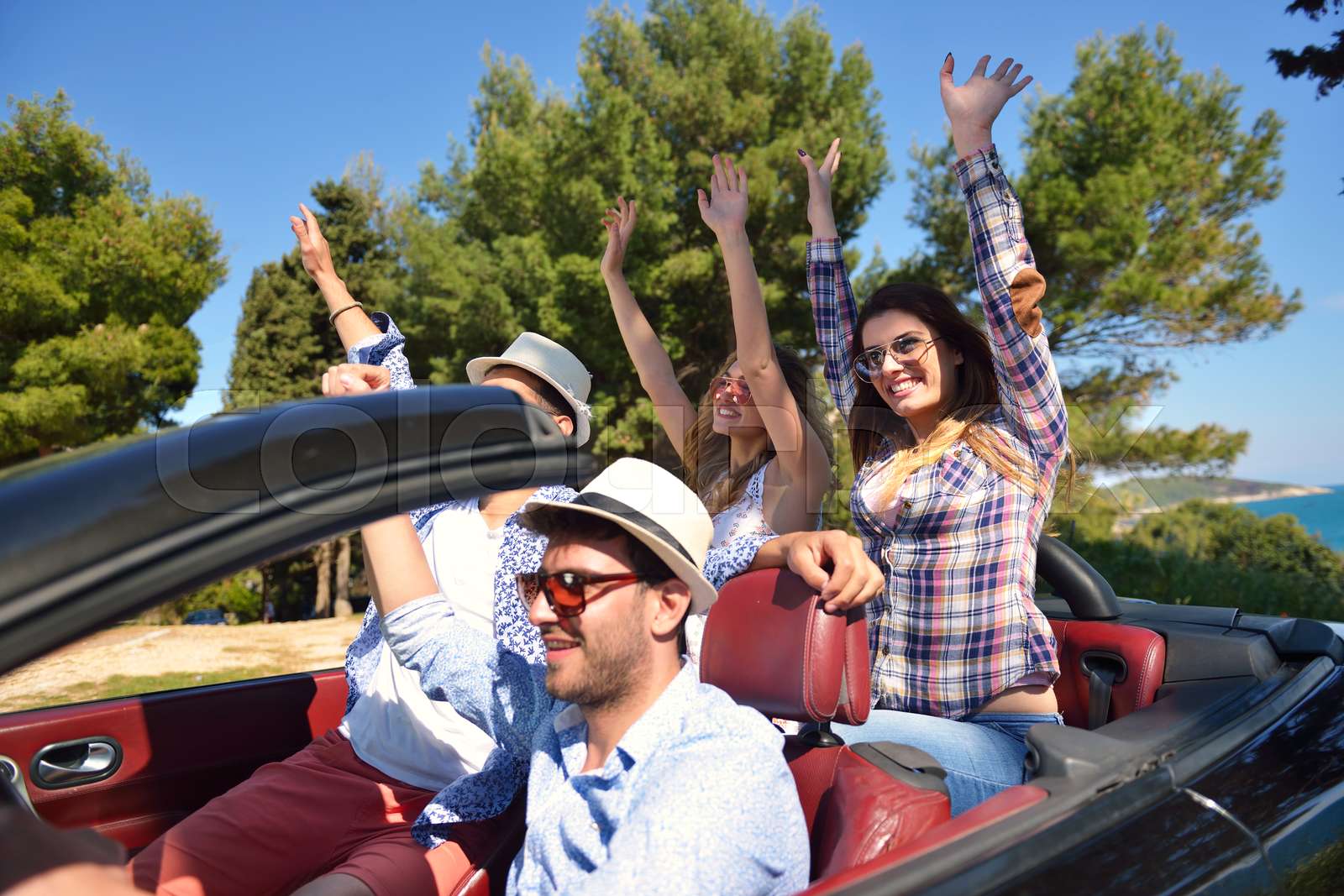 leisure, road trip, travel and people concept - happy friends driving ...