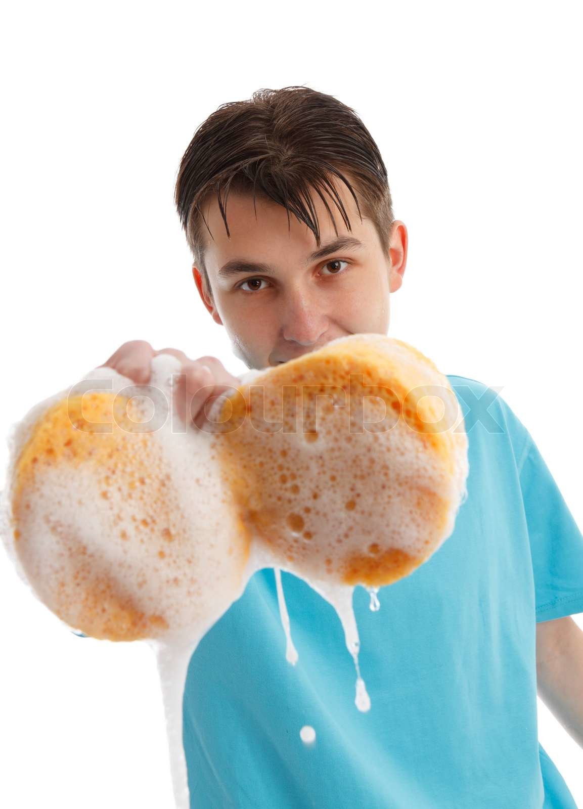 Child holding a sudsy sponge dripping soapy water and bubbles | Stock ...