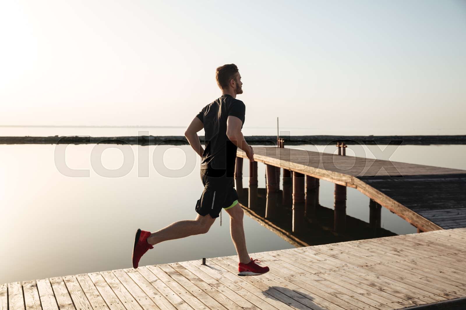 Back view full length portrait of a healthy sportsman running | Stock ...