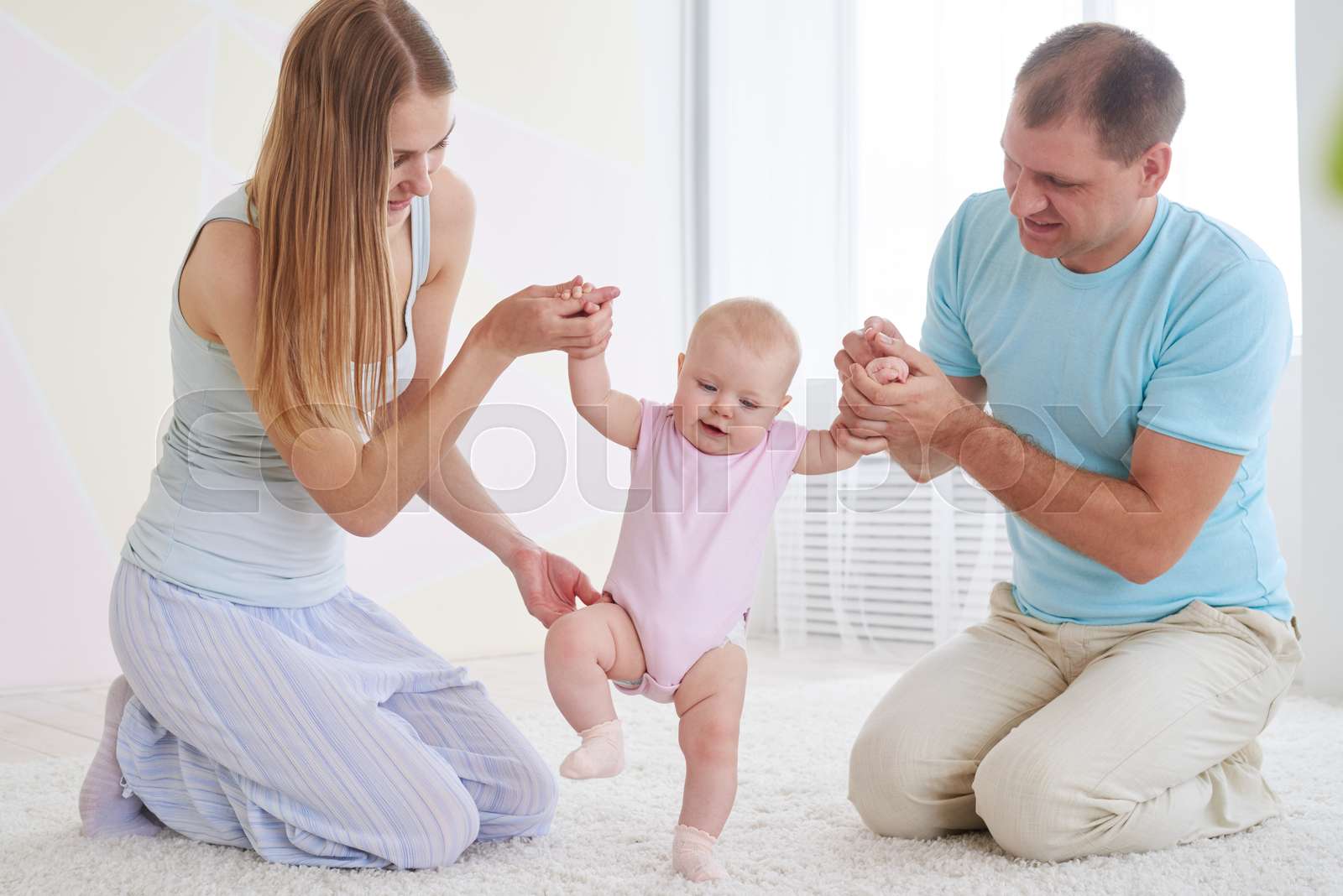 Parents teaching baby to walk | Stock image | Colourbox