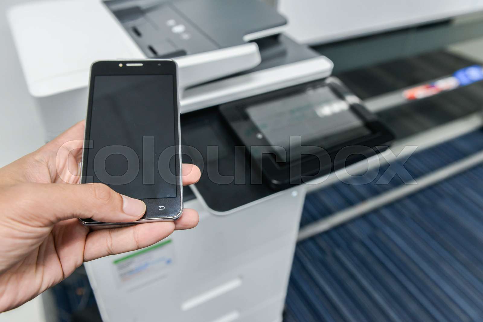 Using smart phone with printer to print the document | Stock image ...