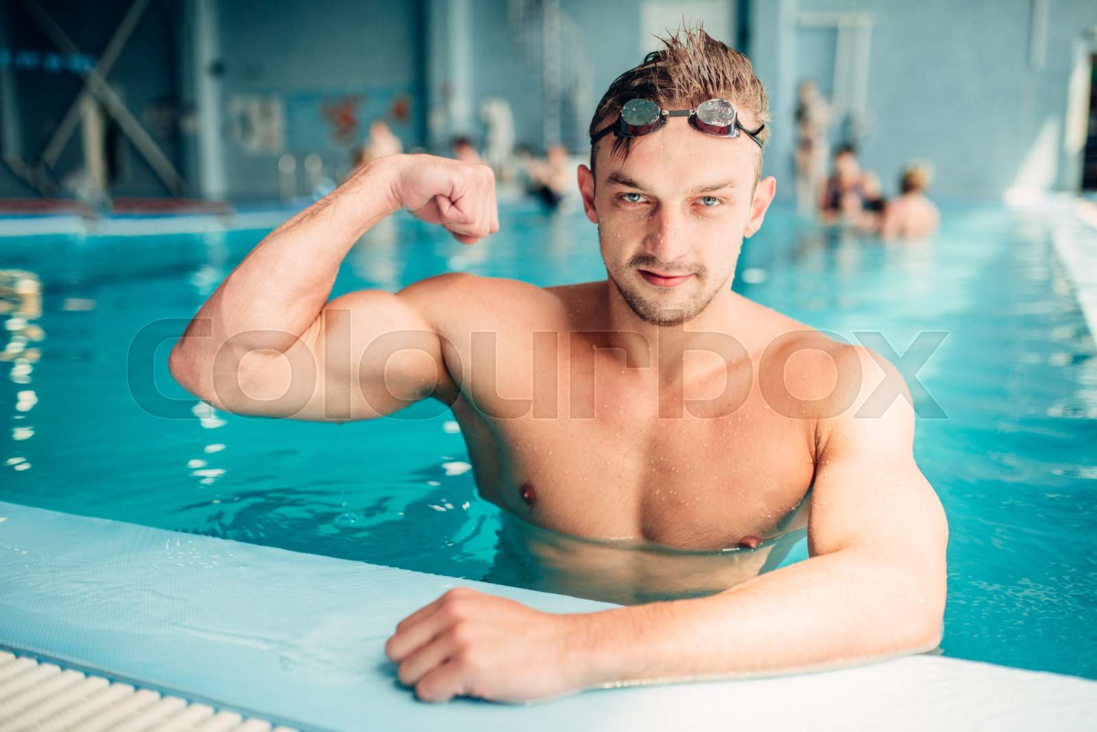 Athletic swimmer shows muscles, aqua sports | Stock image | Colourbox