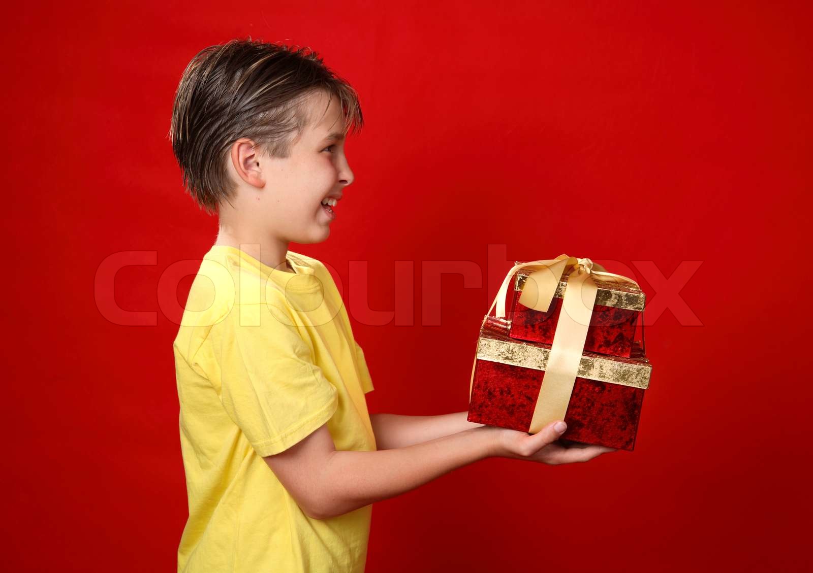 A boy giving festive gifts with a merry smile and a generous heart ...