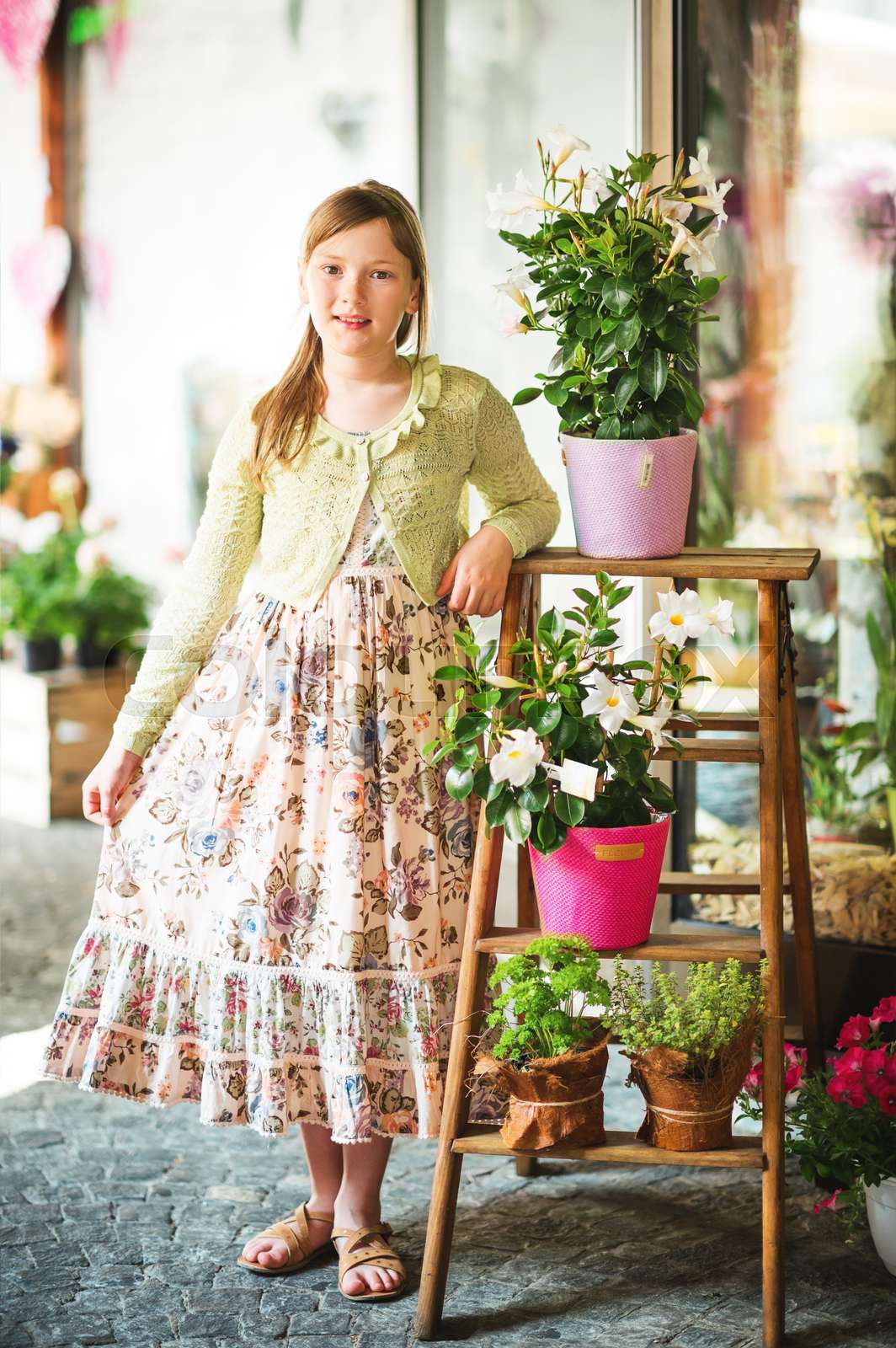 Outdoor portrait of pretty 9-10 year old girl, wearing long summer ...