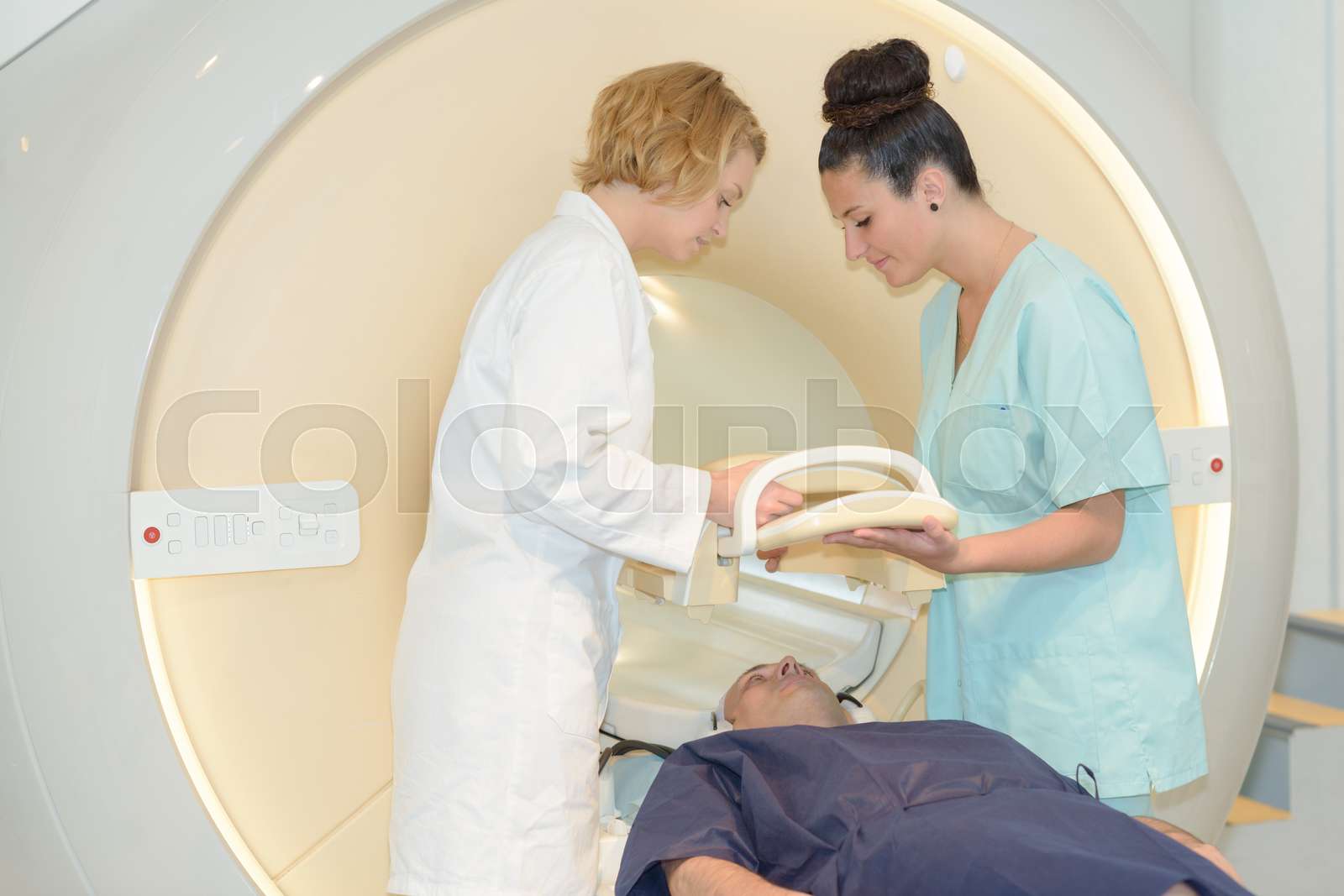 preparing a patient for a scan | Stock image | Colourbox