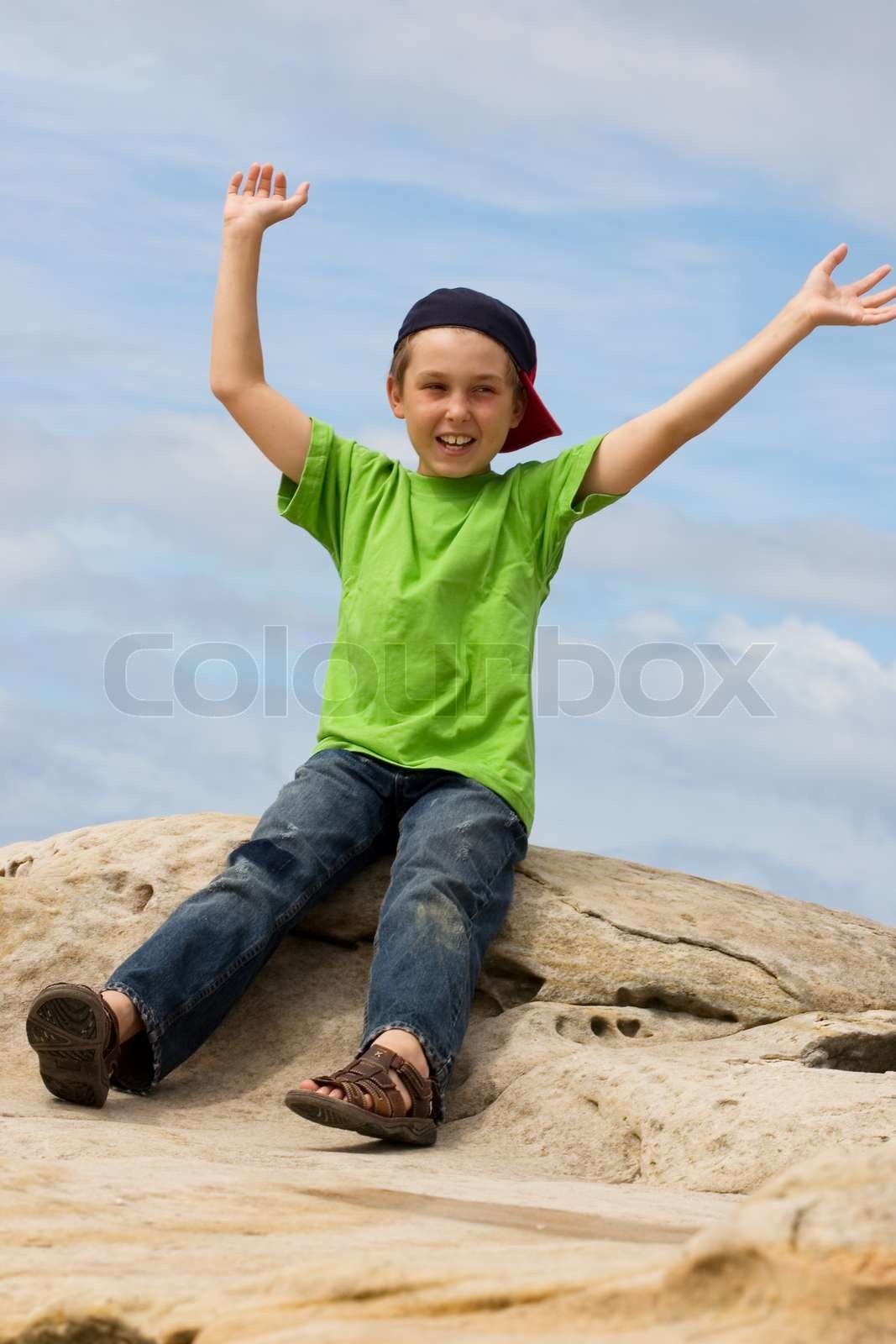 Carefree child waving arms gregariously overhead | Stock image | Colourbox