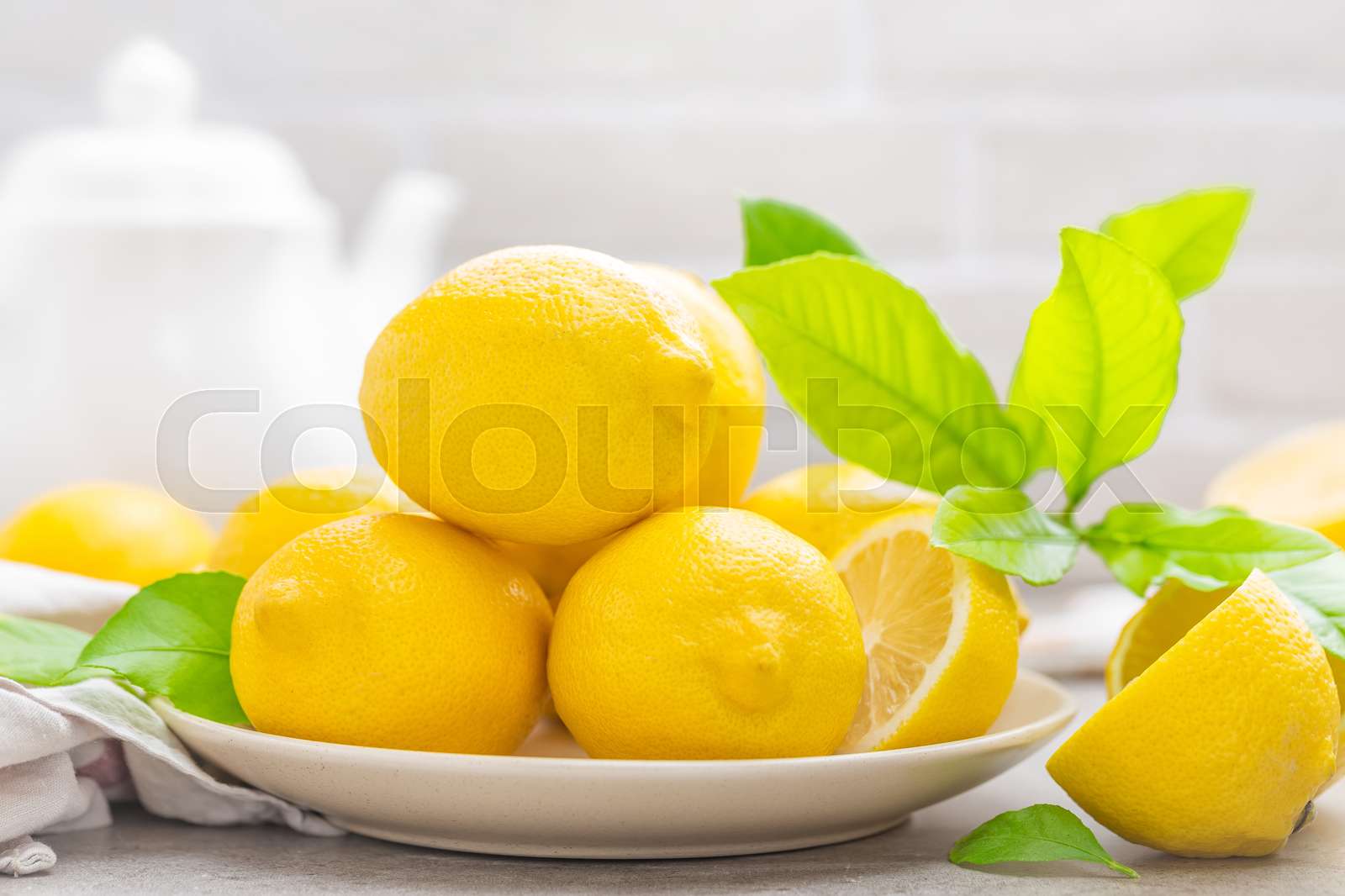 Fresh lemons with lemon leaves | Stock image | Colourbox