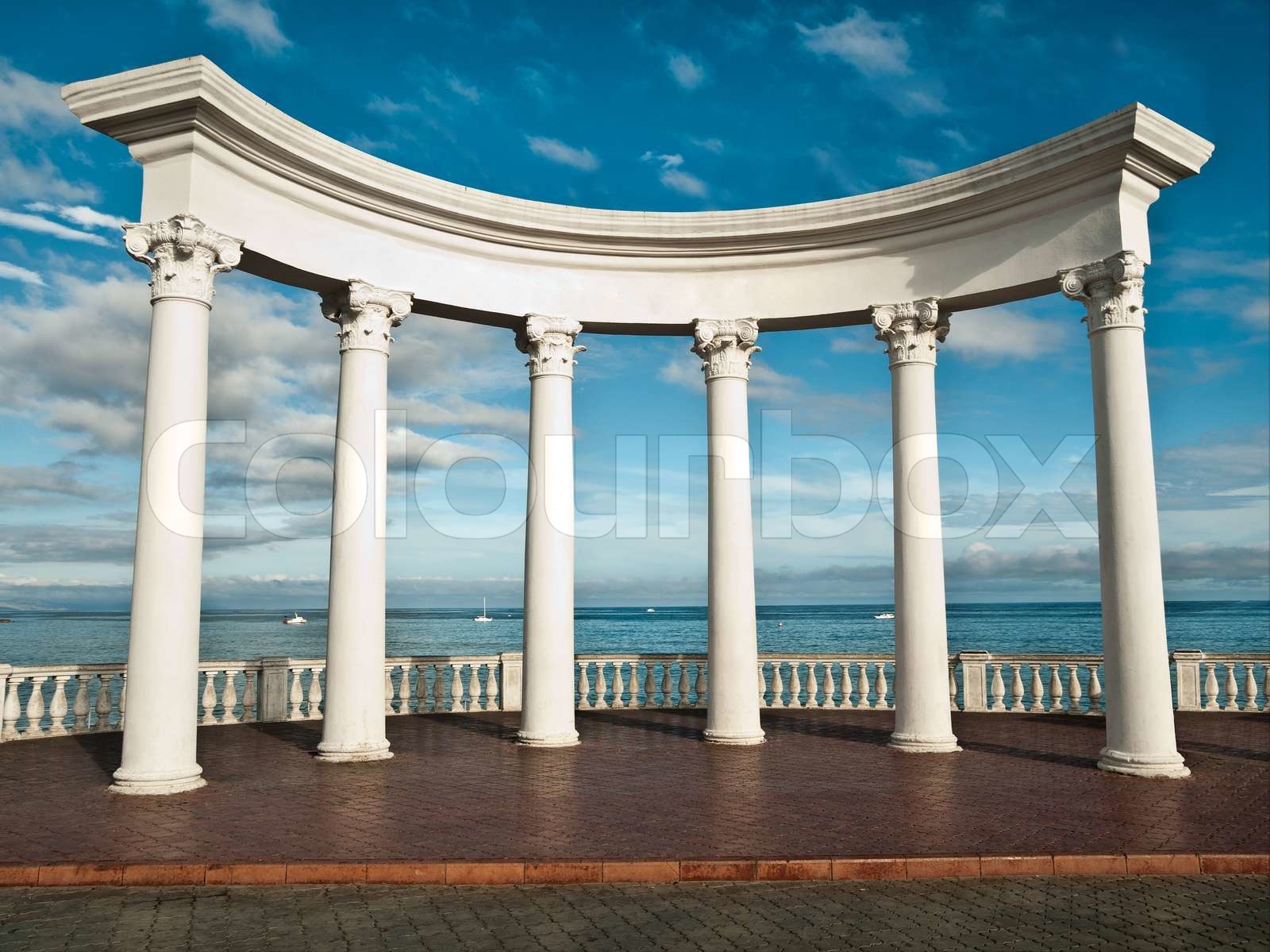 Ancient Greek columns against a blue sky and sea | Stock image | Colourbox