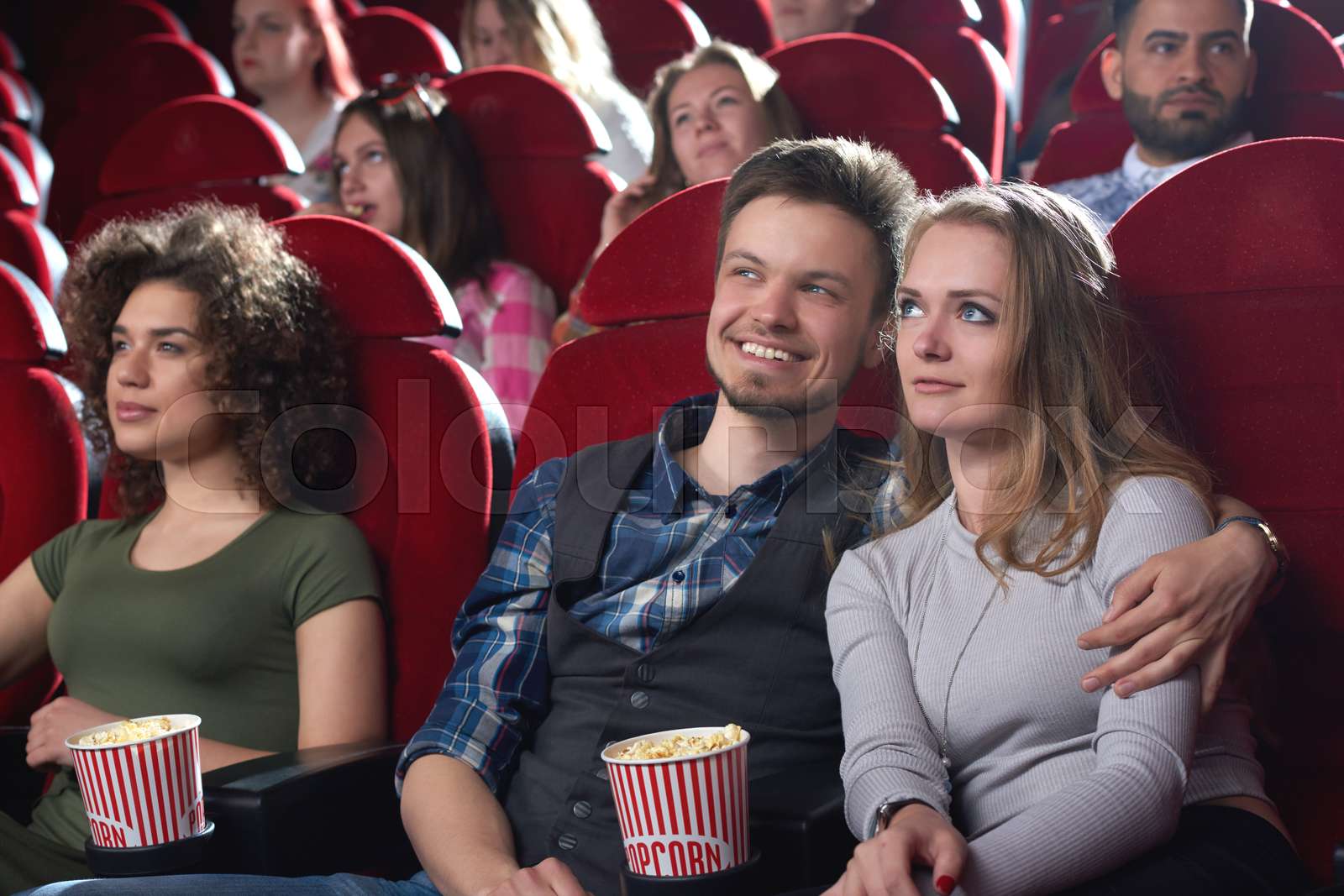 Group of people enjoying movie at the cinema | Stock image | Colourbox