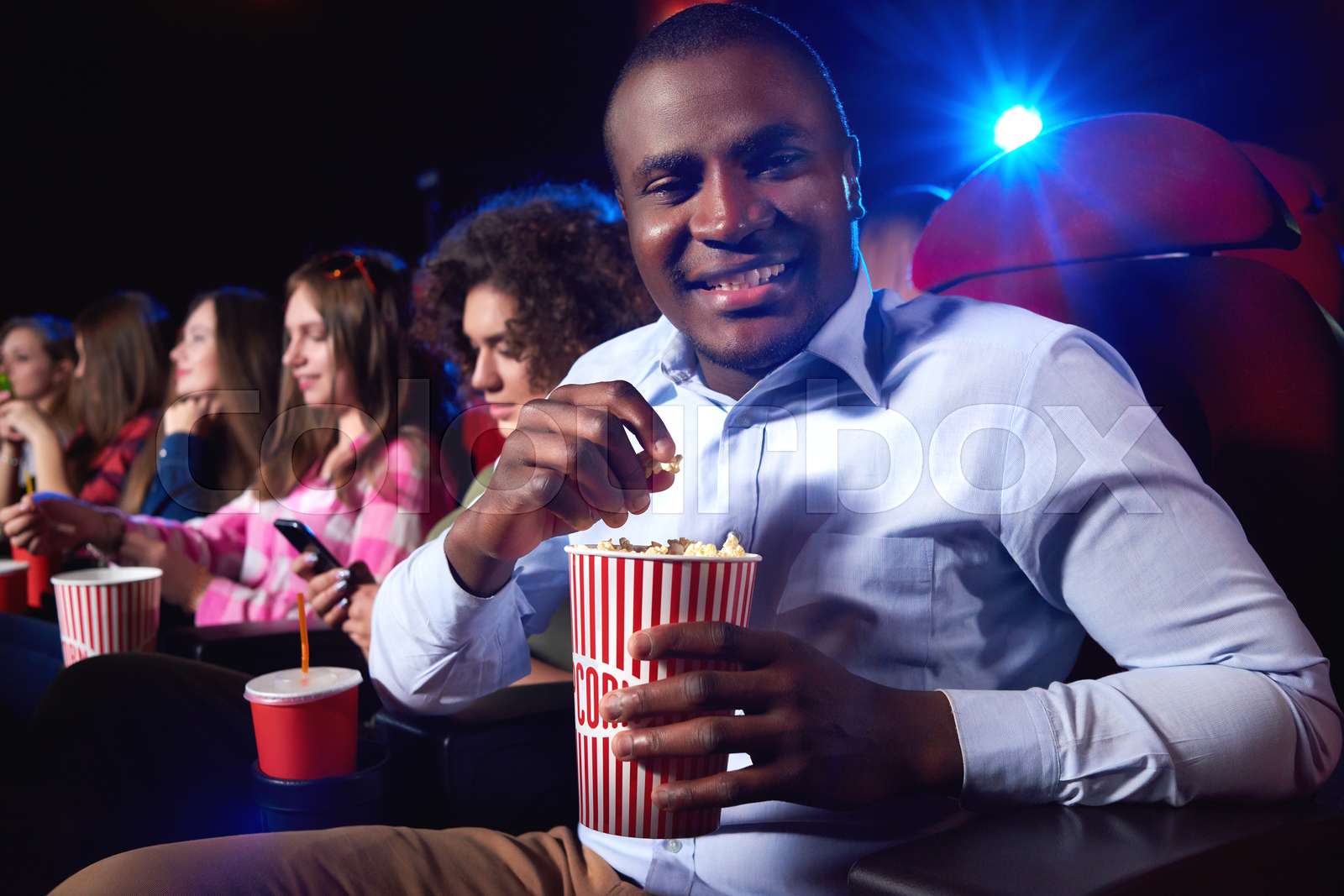 Group of people enjoying movie at the cinema | Stock image | Colourbox
