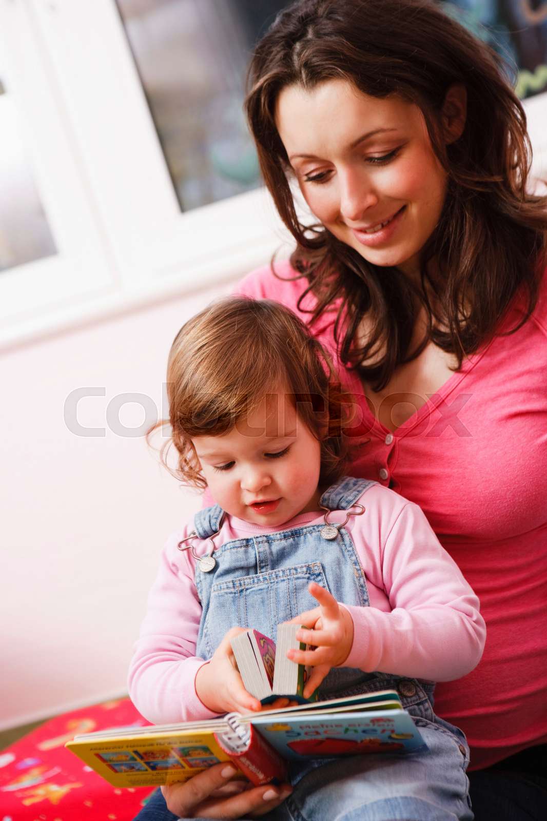Mother and her baby reading book | Stock image | Colourbox