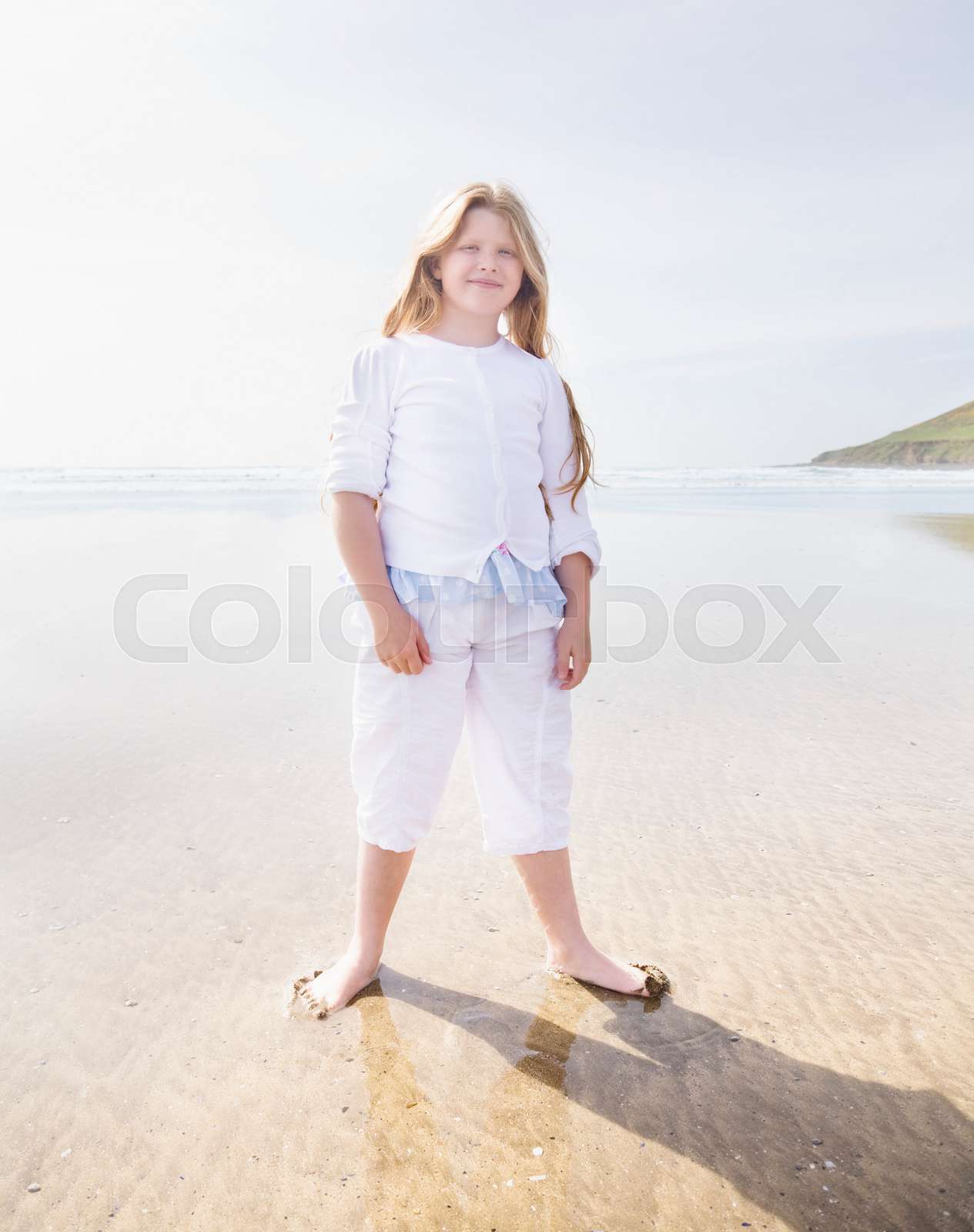 Girl standing on beach | Stock image | Colourbox