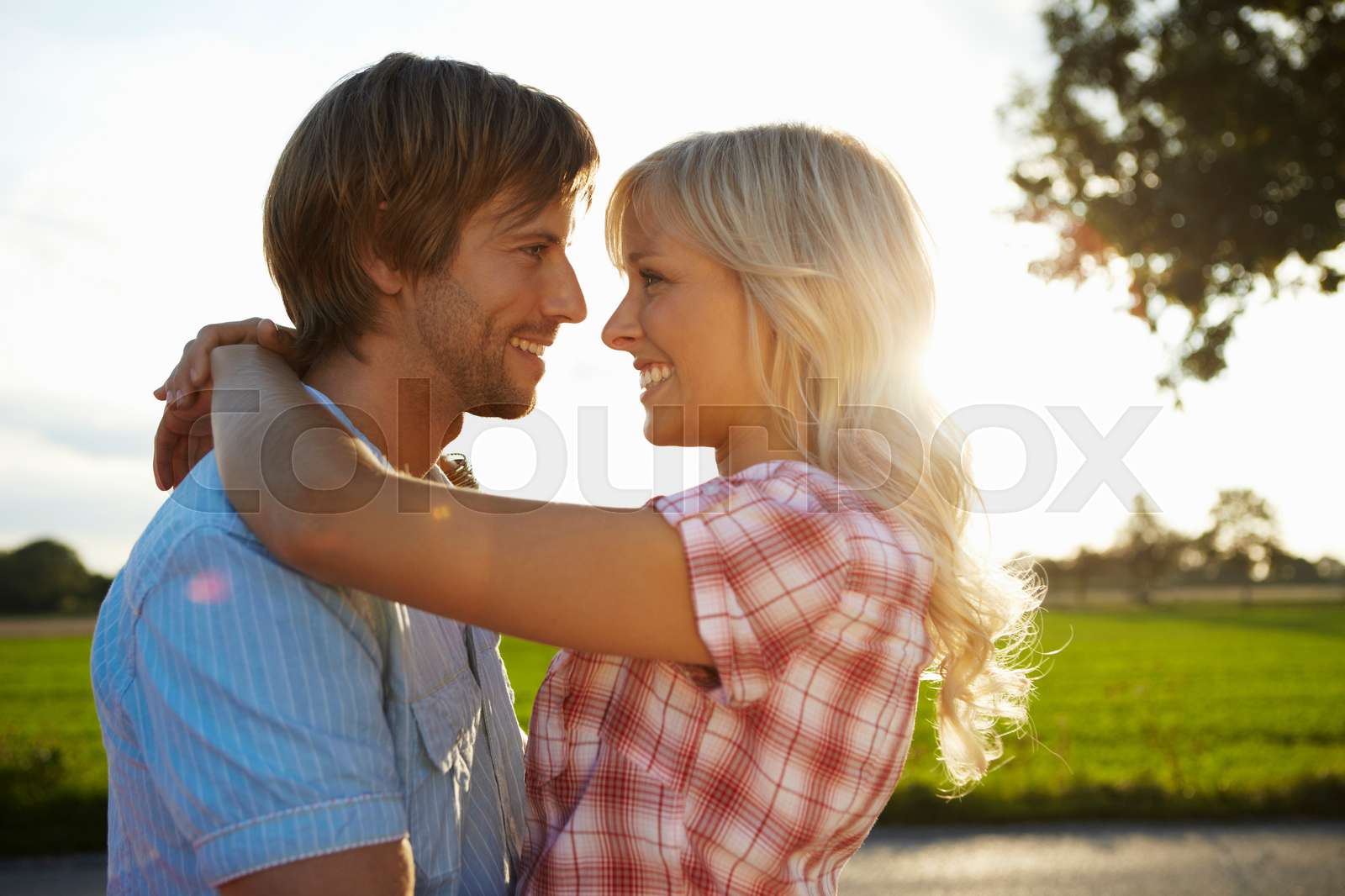 Couple close/hugging during sunset | Stock image | Colourbox