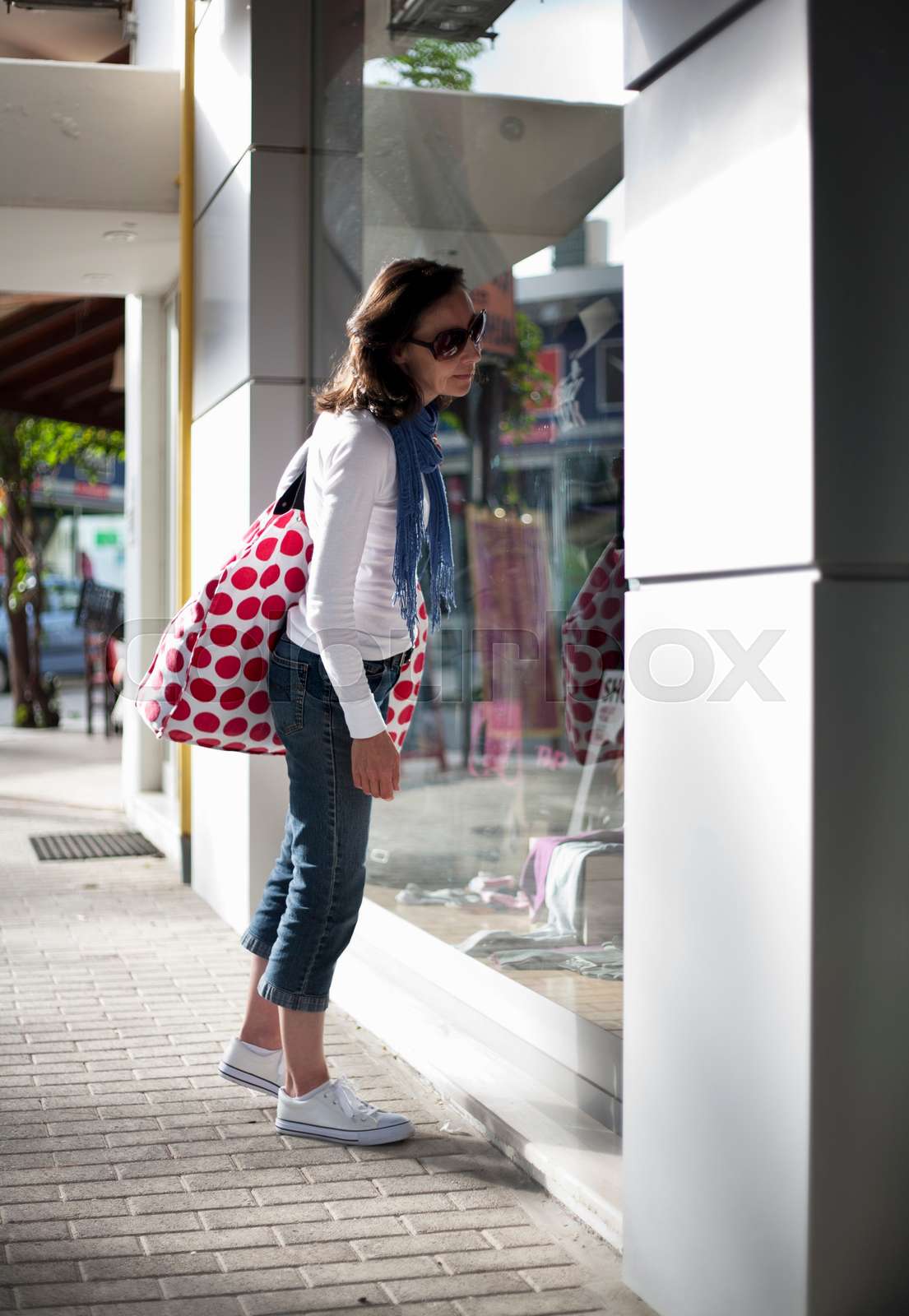 Woman window shopping | Stock image | Colourbox