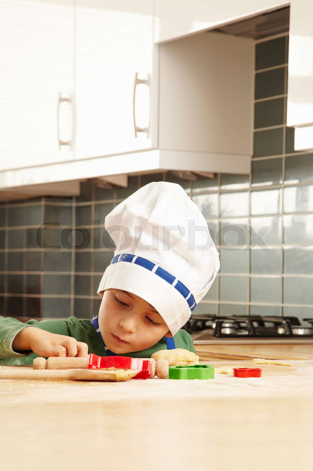 Young boy cooking in kitchen | Stock image | Colourbox