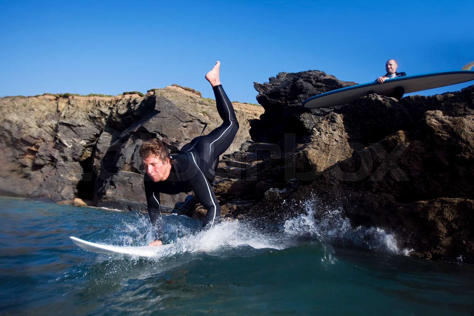 Man jumping onto surfboard | Stock image | Colourbox