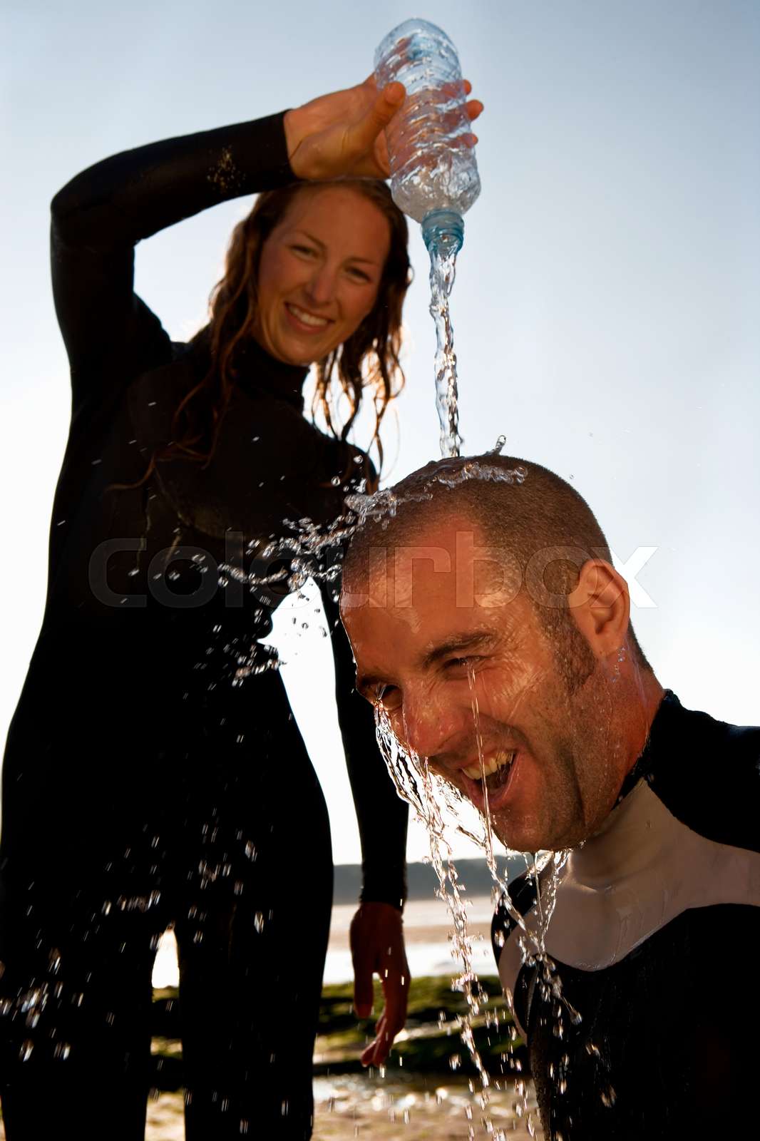 Man pouring water over man | Stock image | Colourbox