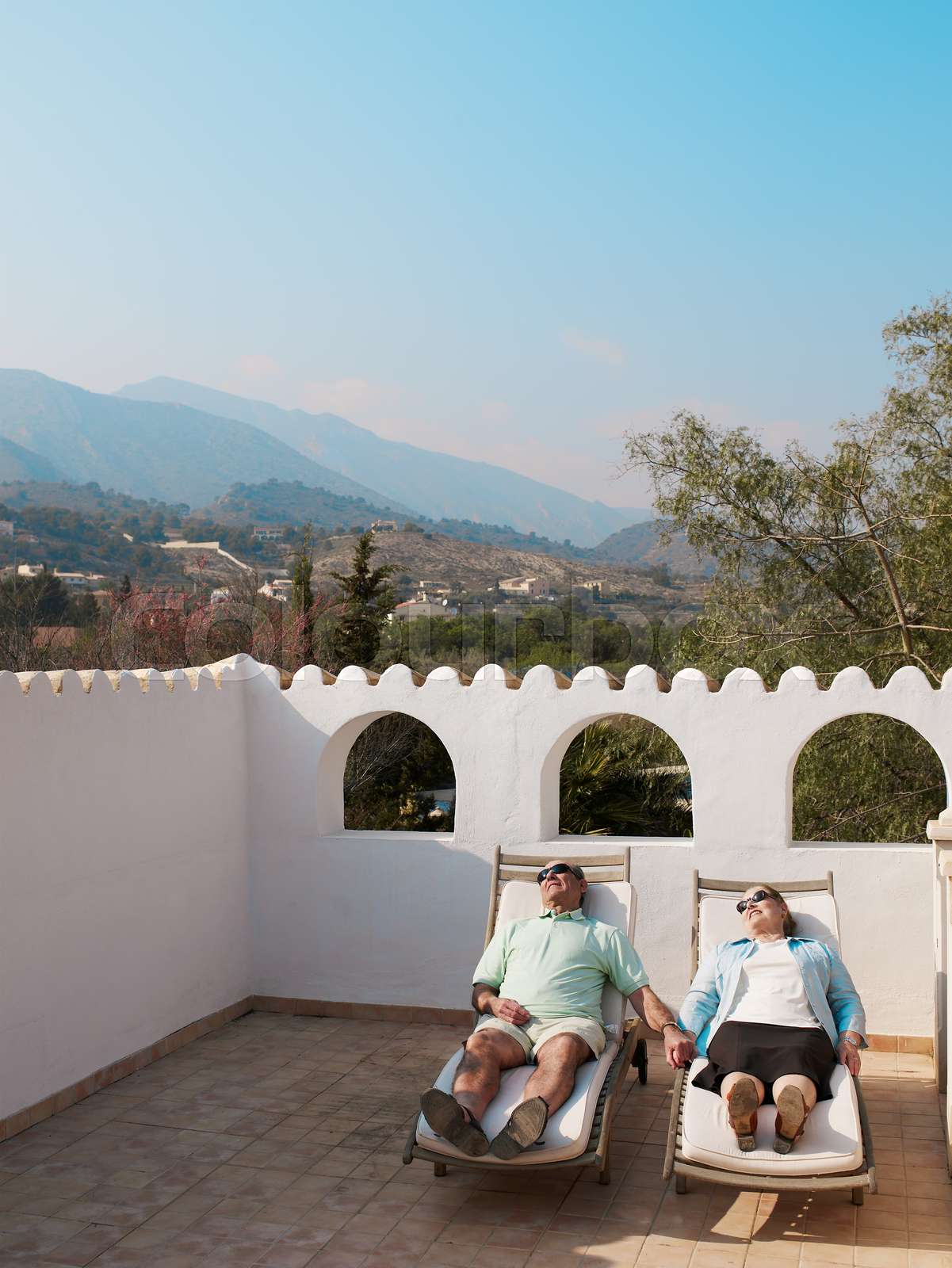 Senior couple sunbathing on balcony | Stock image | Colourbox