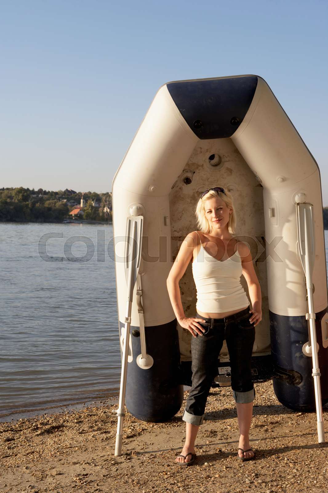 Woman standing on a beach with a raft | Stock image | Colourbox
