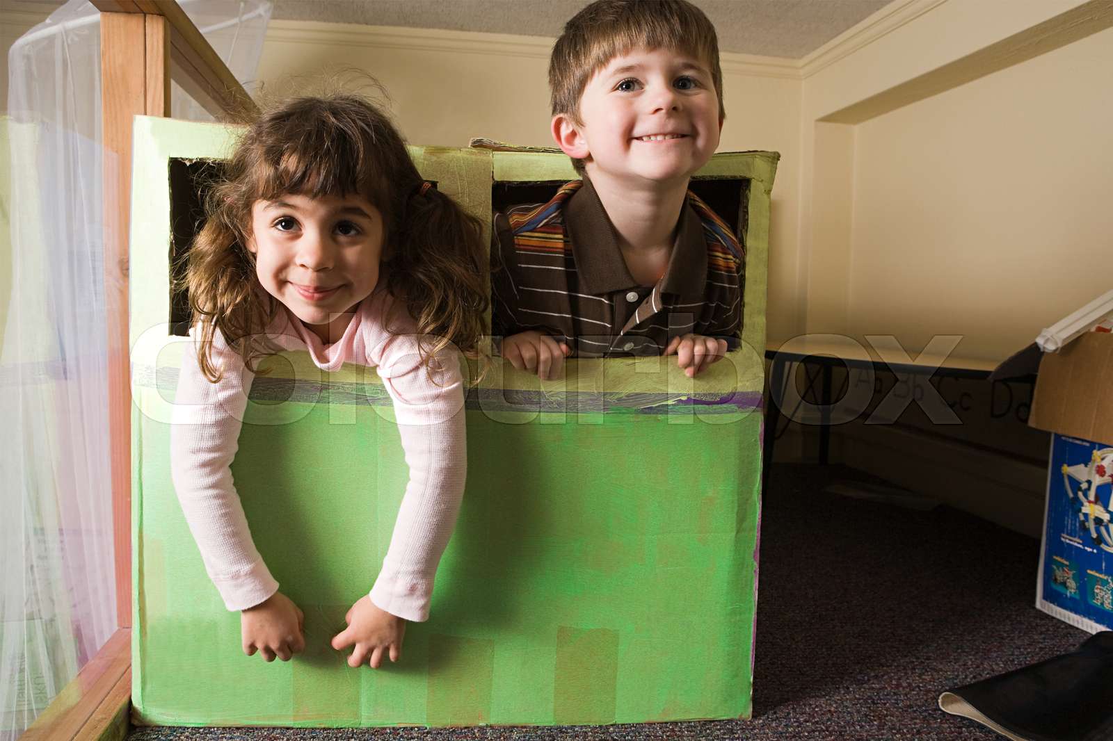 Children playing in a box | Stock image | Colourbox