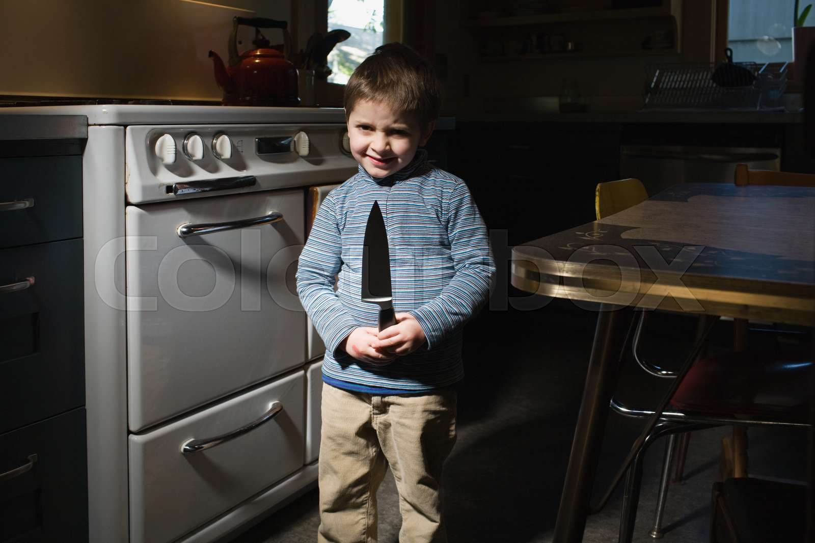 Little boy with knife | Stock image | Colourbox