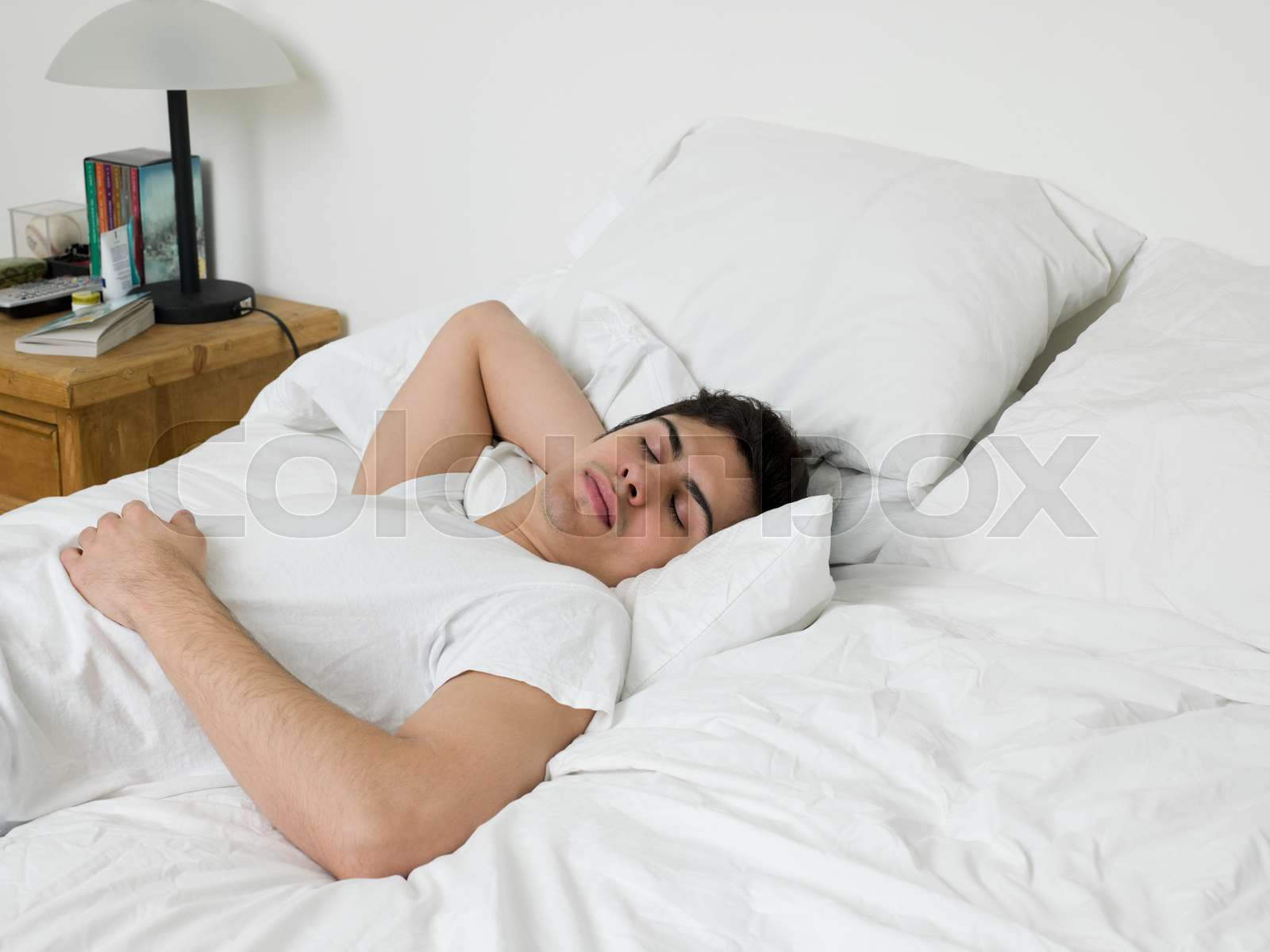 Man asleep on bed | Stock image | Colourbox