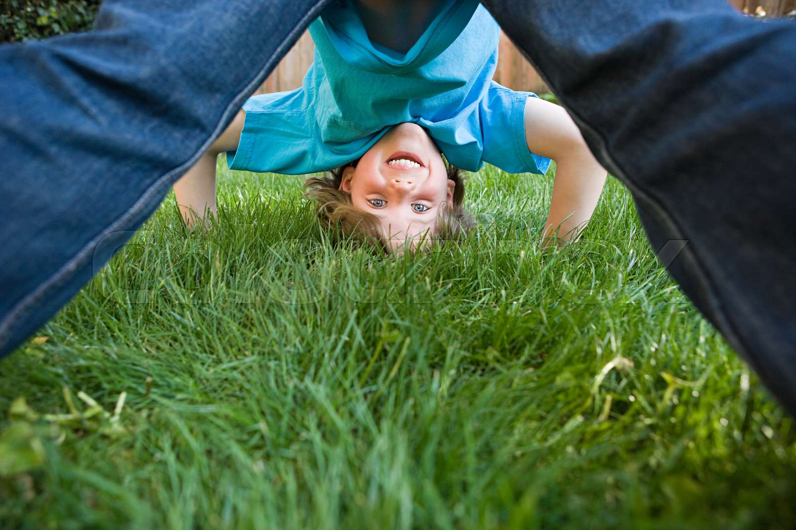 Boy playing on grass | Stock image | Colourbox