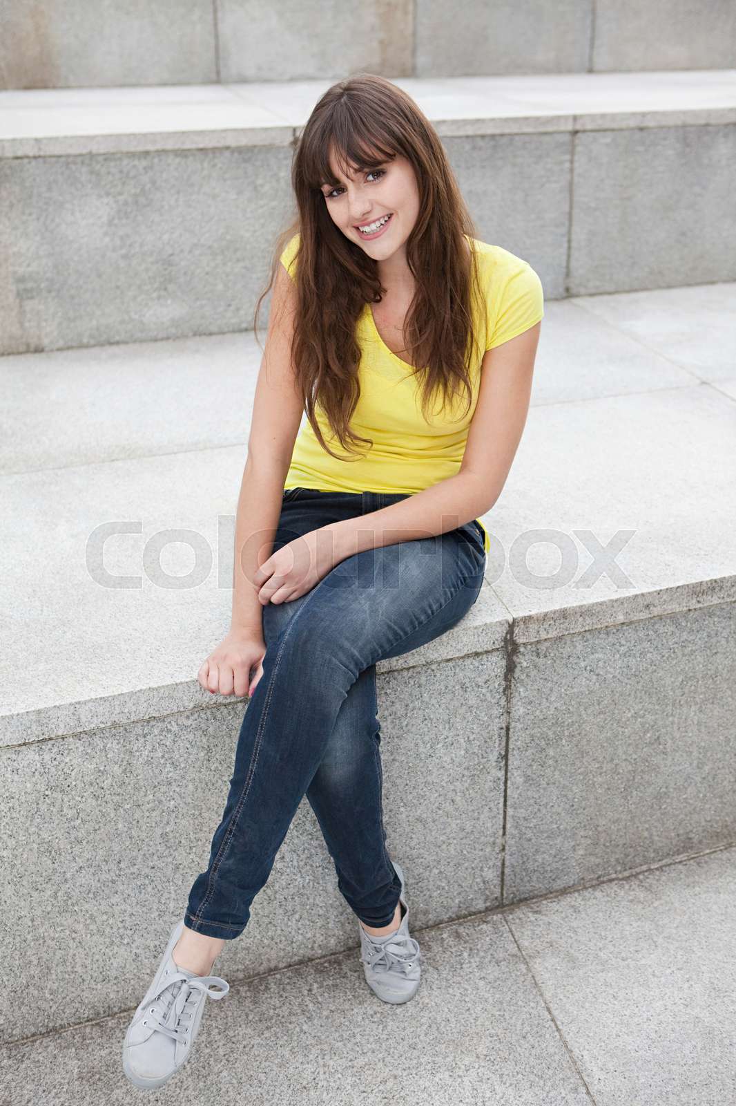 Young woman sitting on step | Stock image | Colourbox