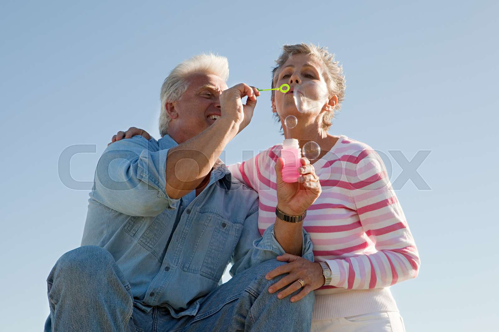 Mature couple blowing bubbles | Stock image | Colourbox