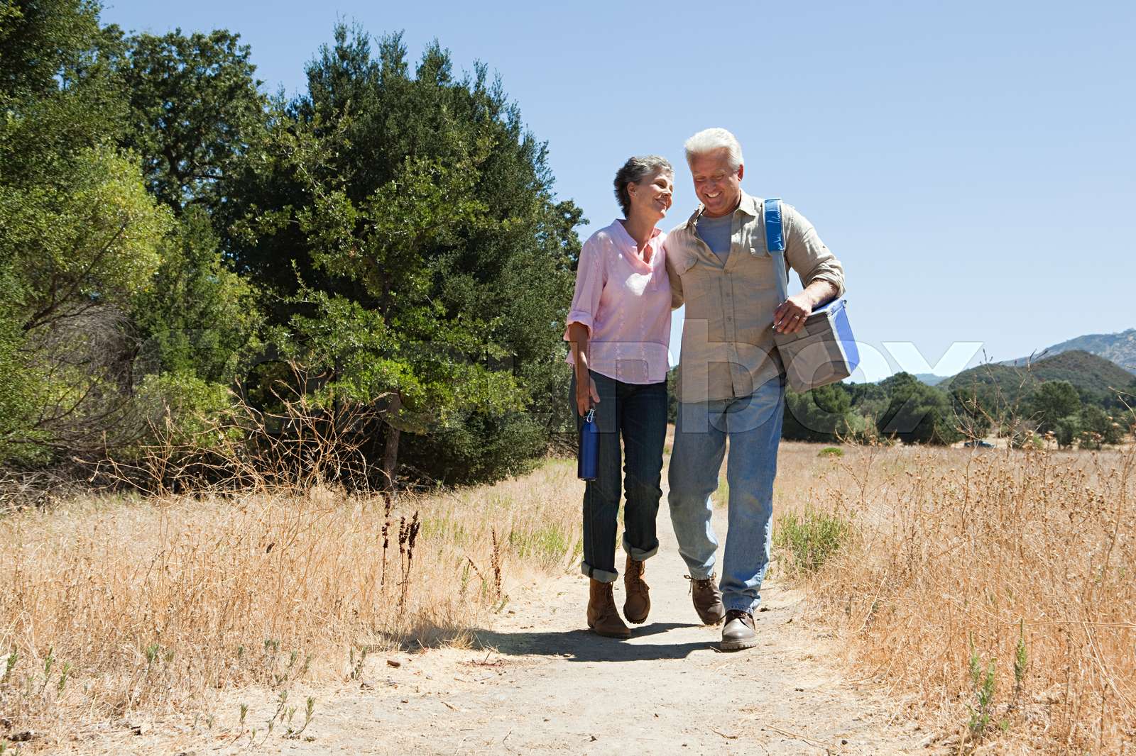Mature couple walking on rural path | Stock image | Colourbox