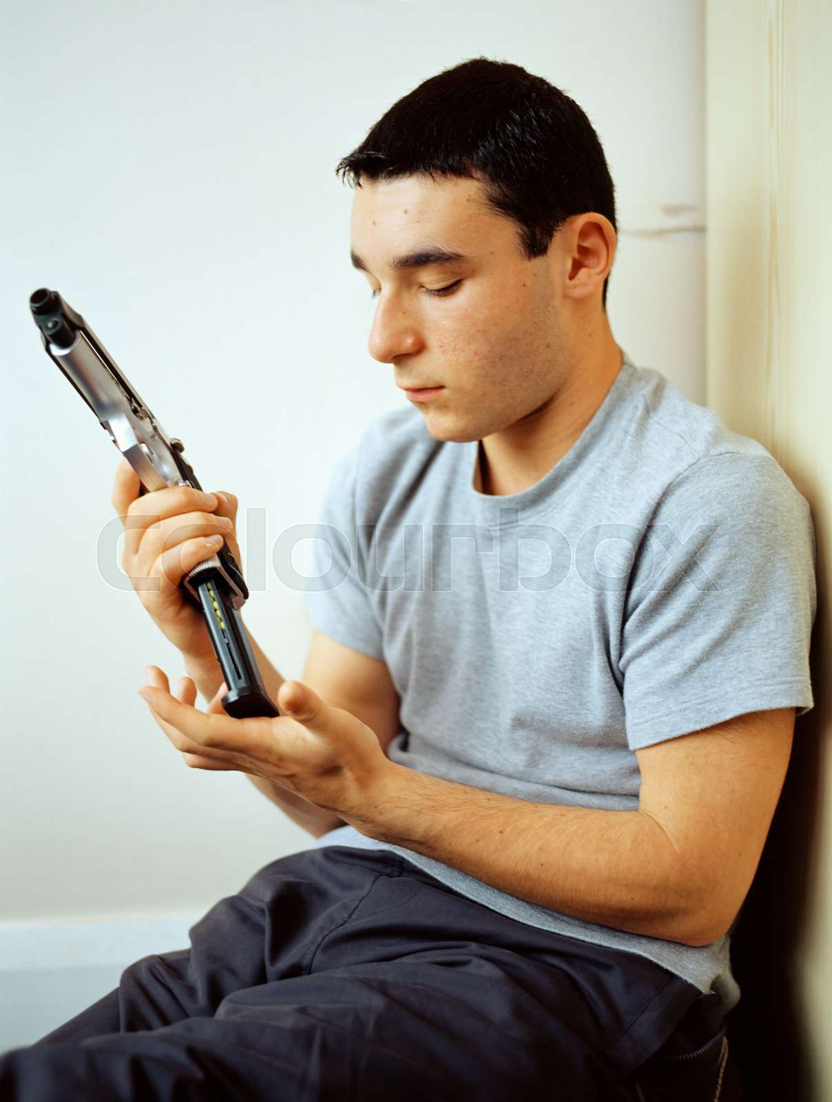 Boy holding a toy gun | Stock image | Colourbox