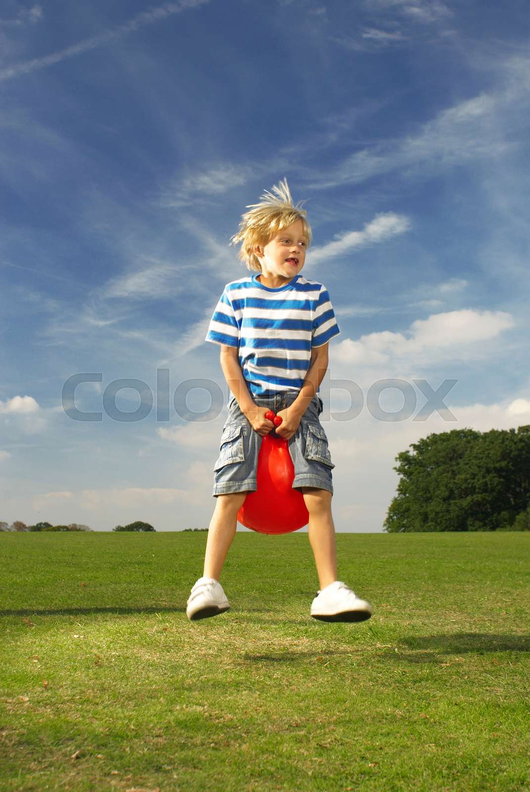 boy bouncing on space hopper | Stock image | Colourbox