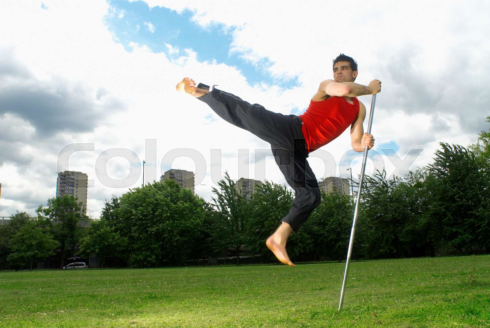 man jumping using bow staff | Stock image | Colourbox