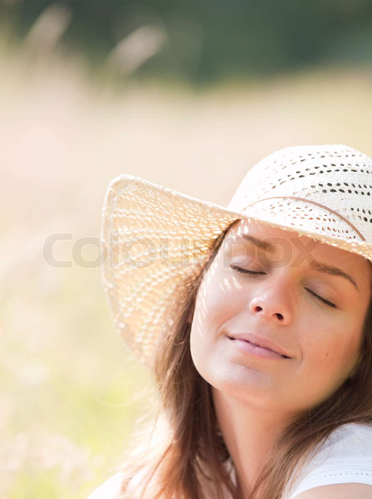 woman in hat smiling,eyes closed | Stock image | Colourbox
