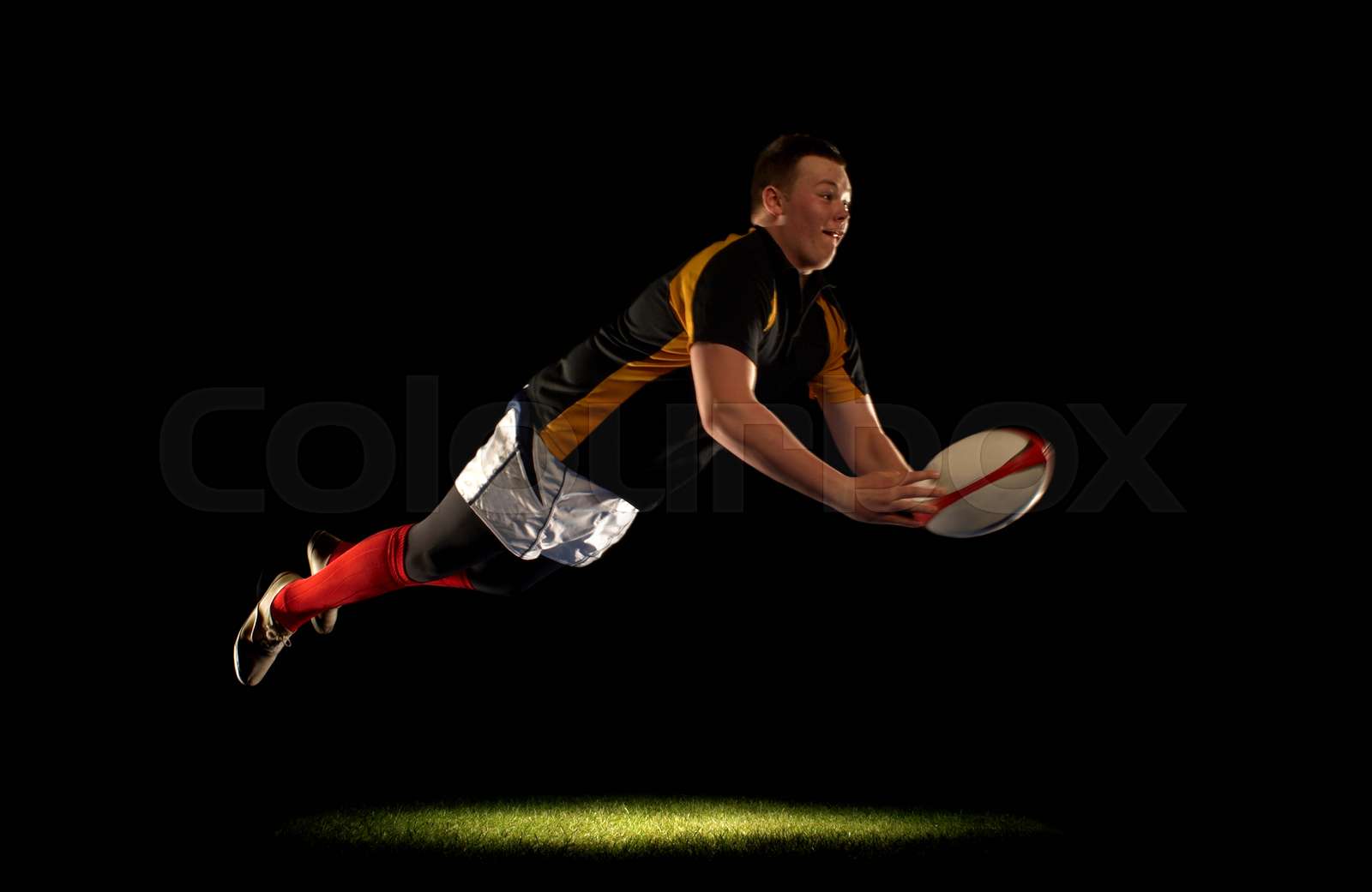 Rugby player diving an throwing ball | Stock image | Colourbox