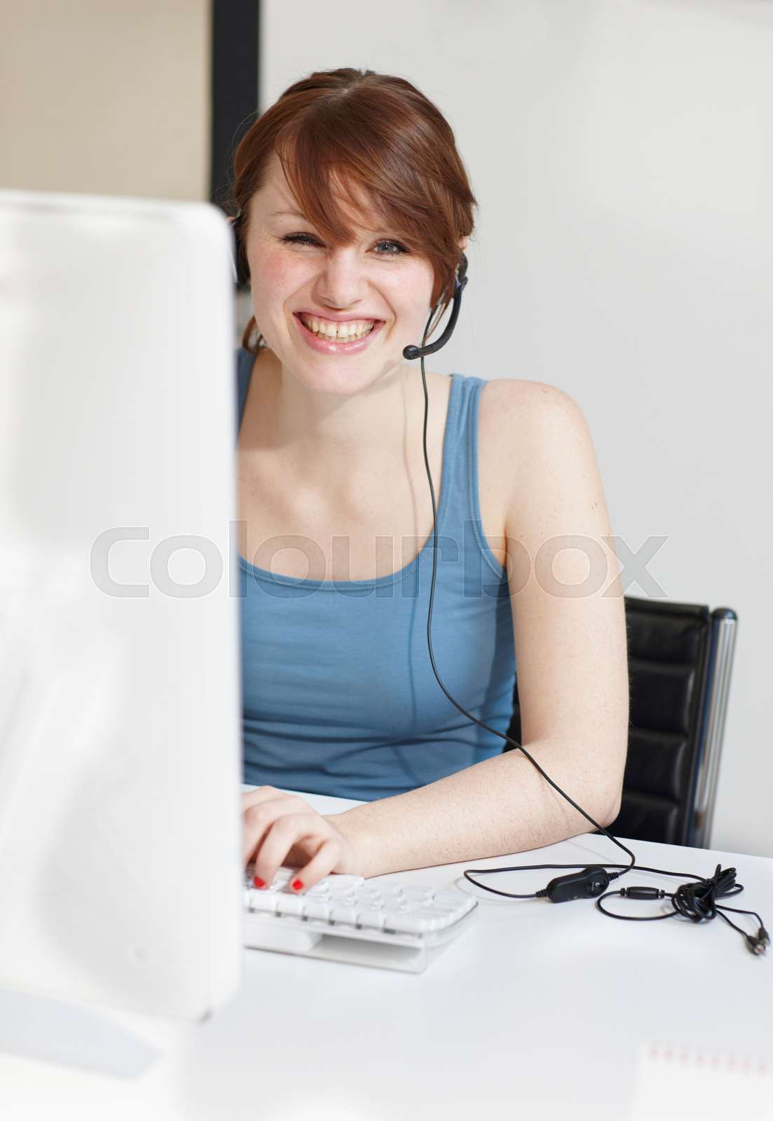 Women with Headset an Computer laughing | Stock image | Colourbox