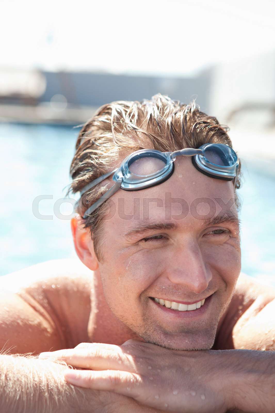 Man wearing goggles in swimming pool | Stock image | Colourbox