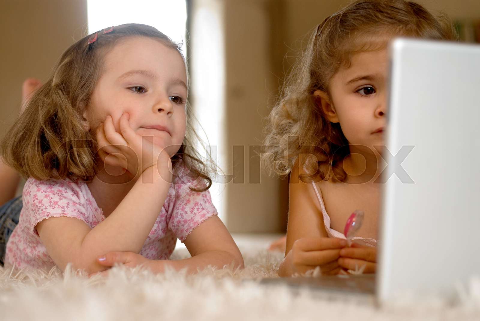 Two girls using laptop. | Stock image | Colourbox