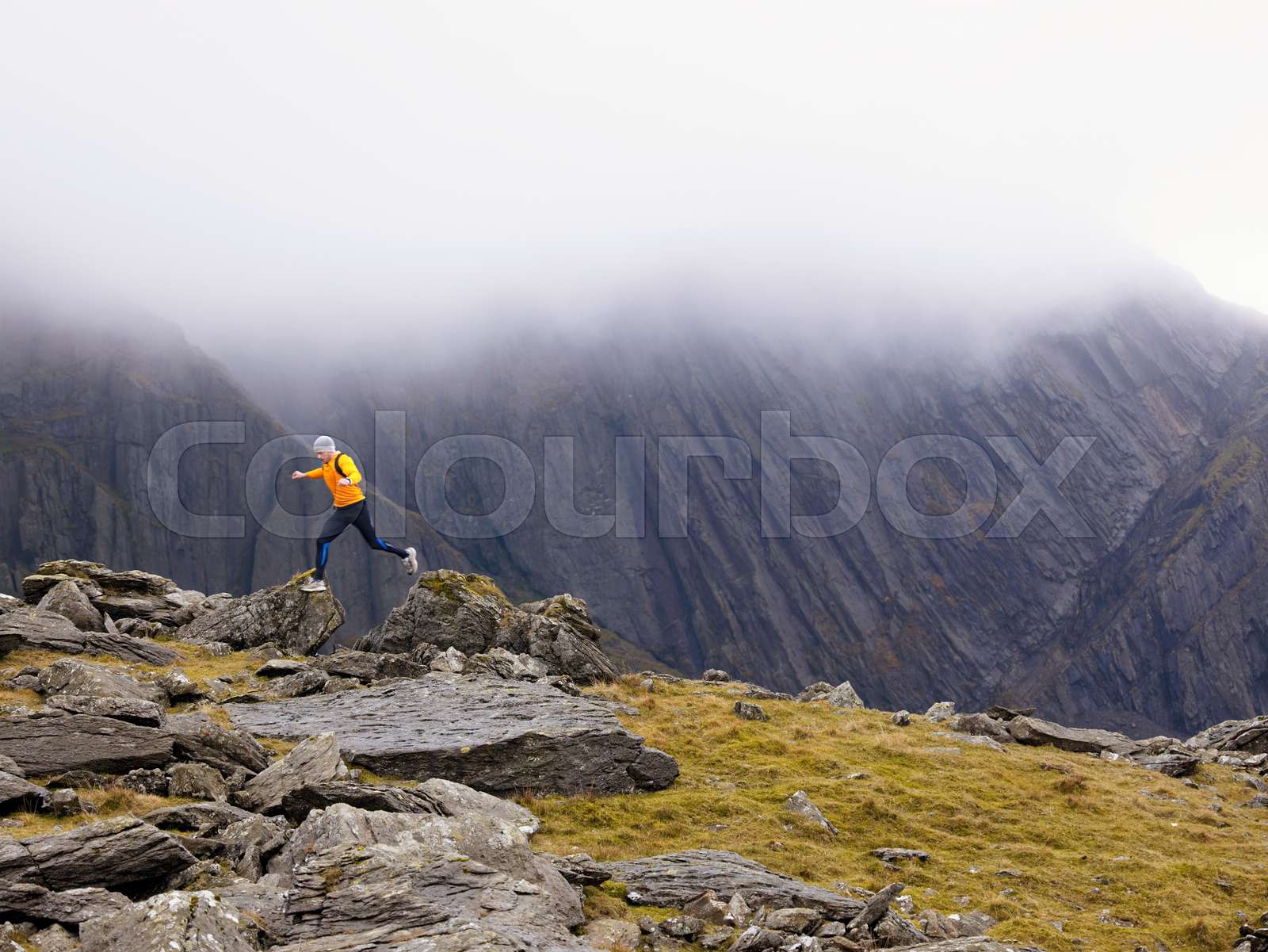 Man jumping off rock | Stock image | Colourbox
