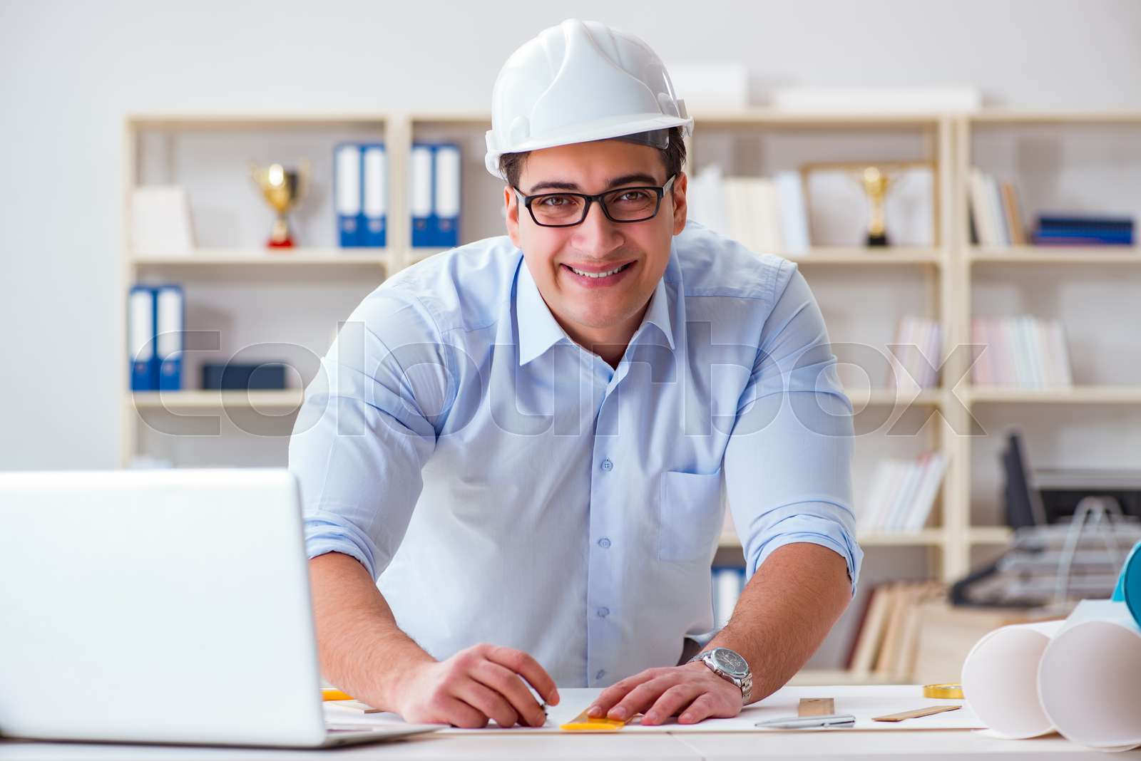 Male engineer working on drawings and blueprints | Stock image | Colourbox