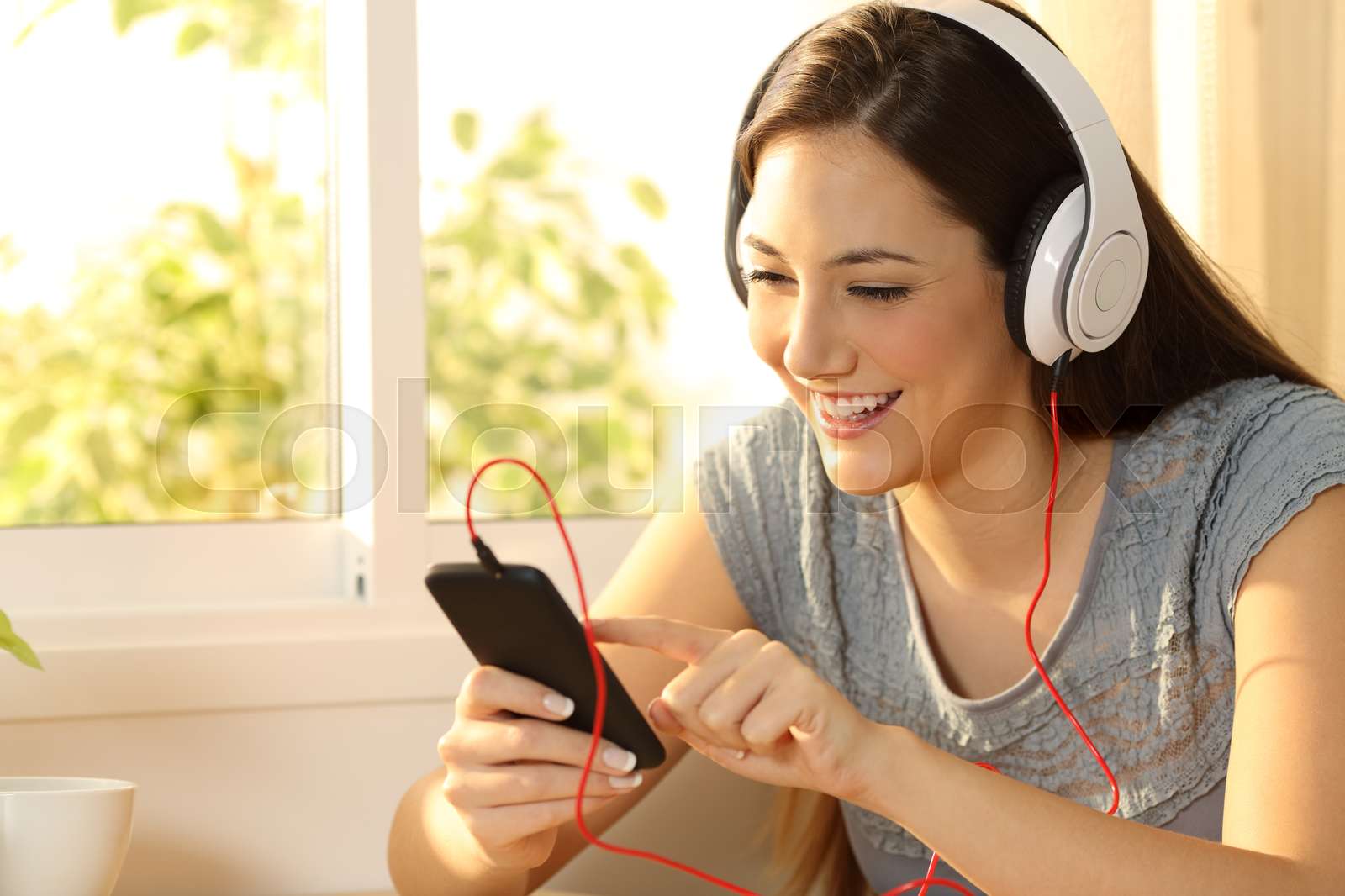 Girl listening music selecting song | Stock image | Colourbox