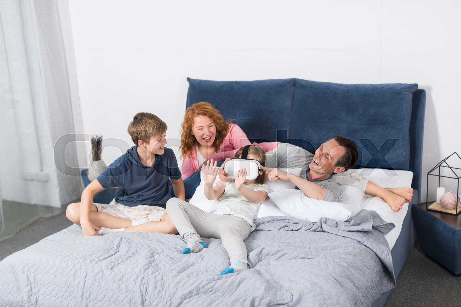 Daughter Wearing Virtual Reality Digital Glasses Sitting With Parents ...